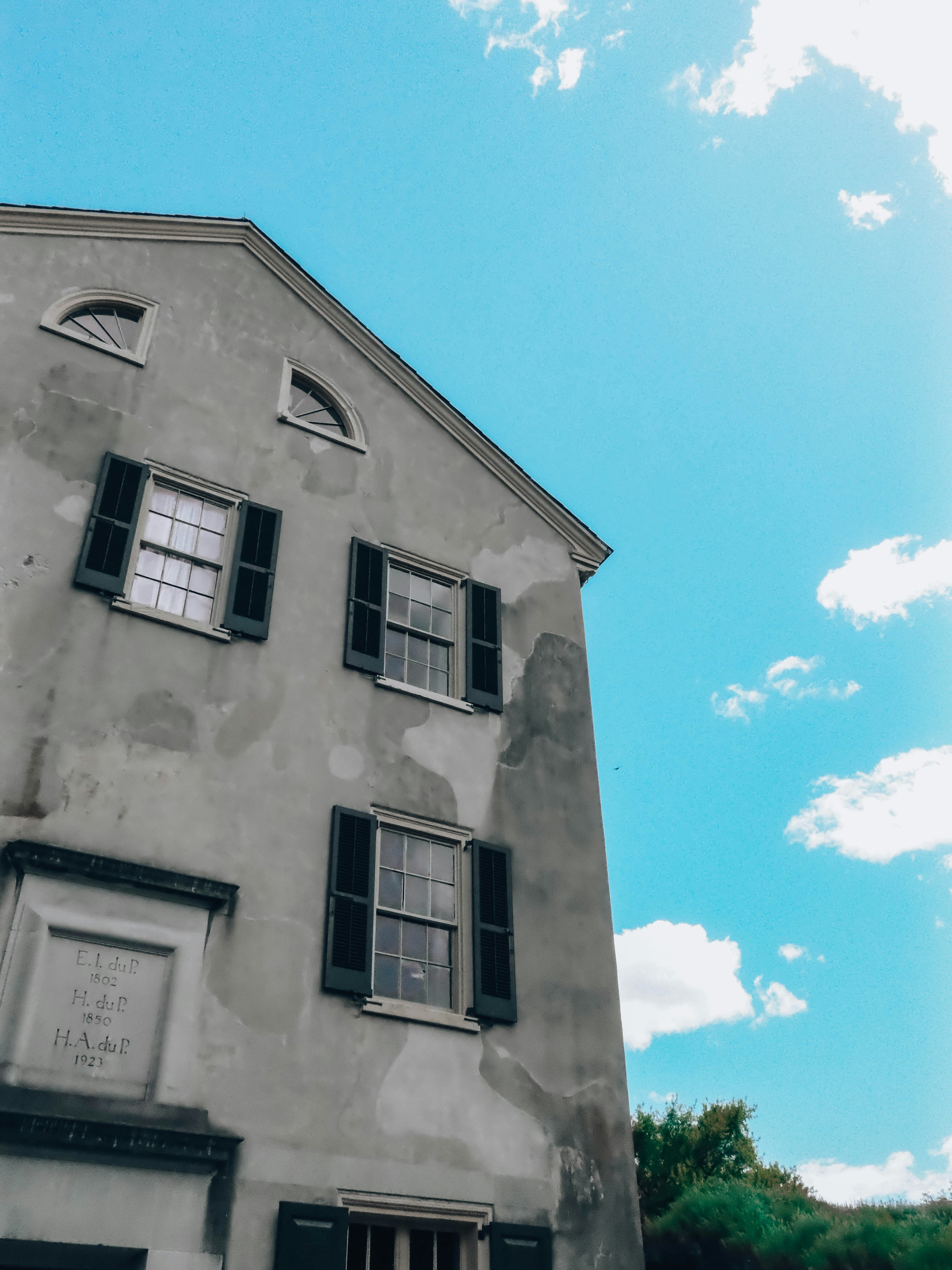 Facade Against a Bright Sky: An Old Building Tilted Toward Tomorrow