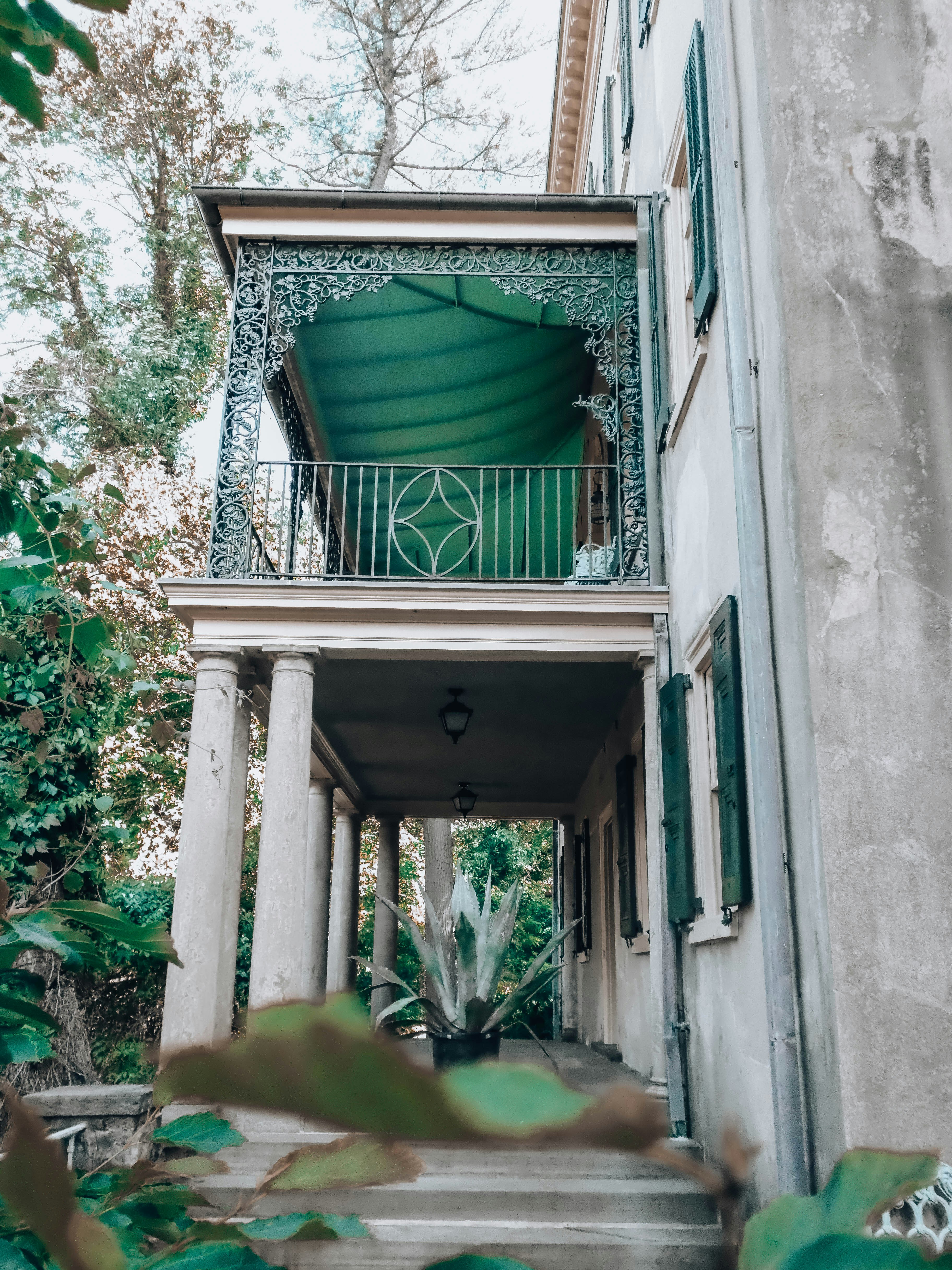 Ironwork Balcony Over a Quiet Courtyard Corridor