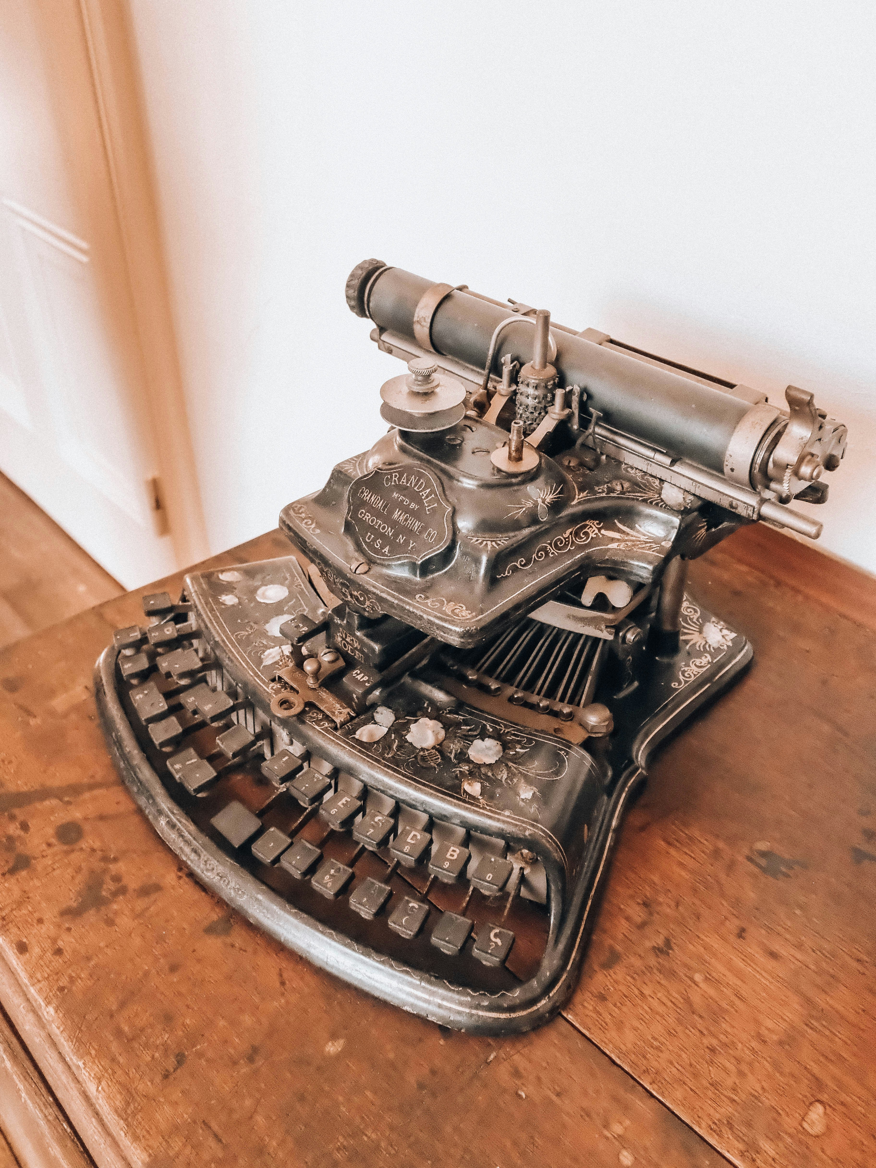 Vintage Desk Companion: An Ornate Old-World Typewriter with Weathered Charm