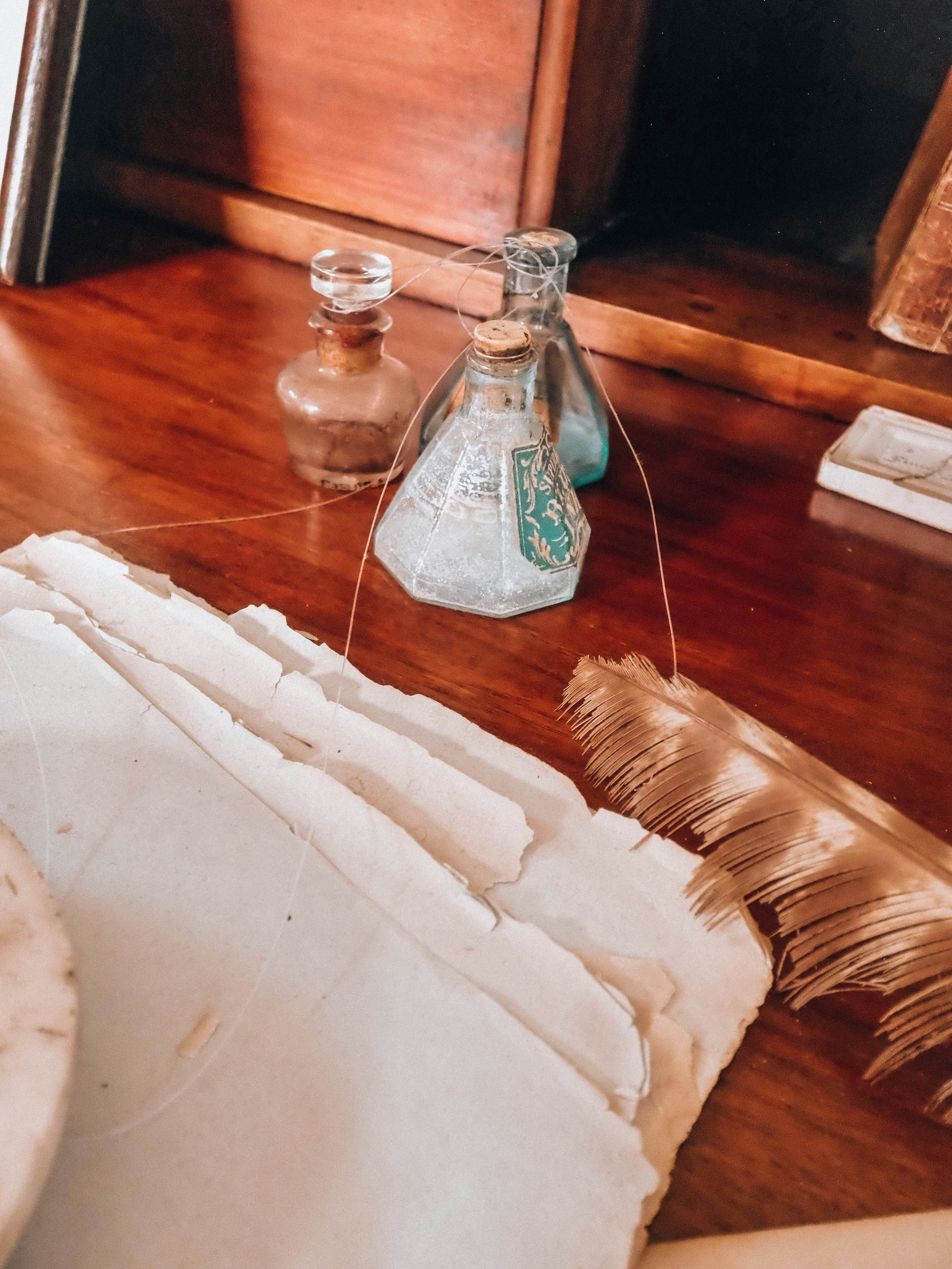 Quill and Quarters: a Still Life of Ink, Glass, and Feather