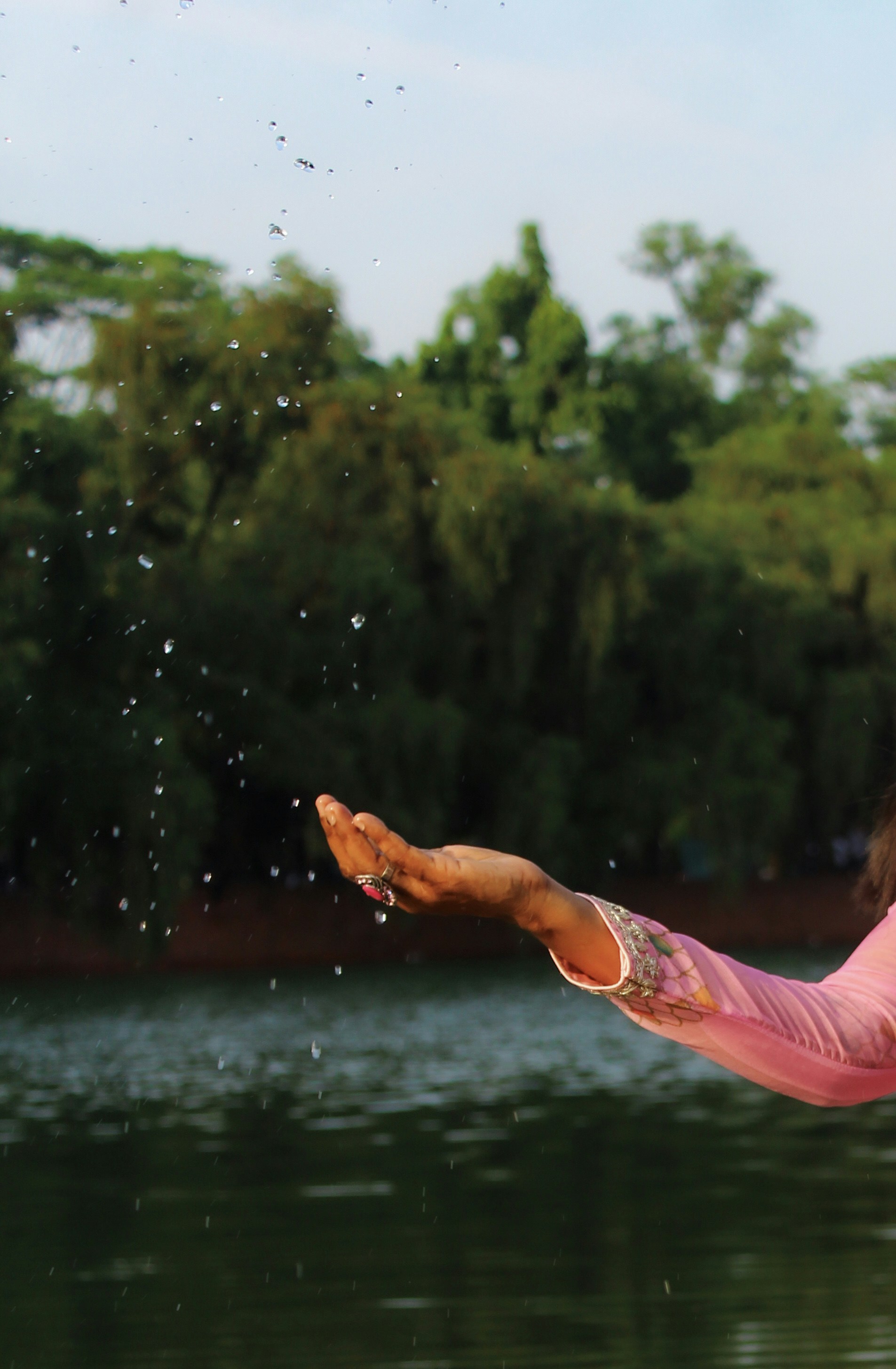 Graceful Splash: A Hand Reaching Toward Falling Water