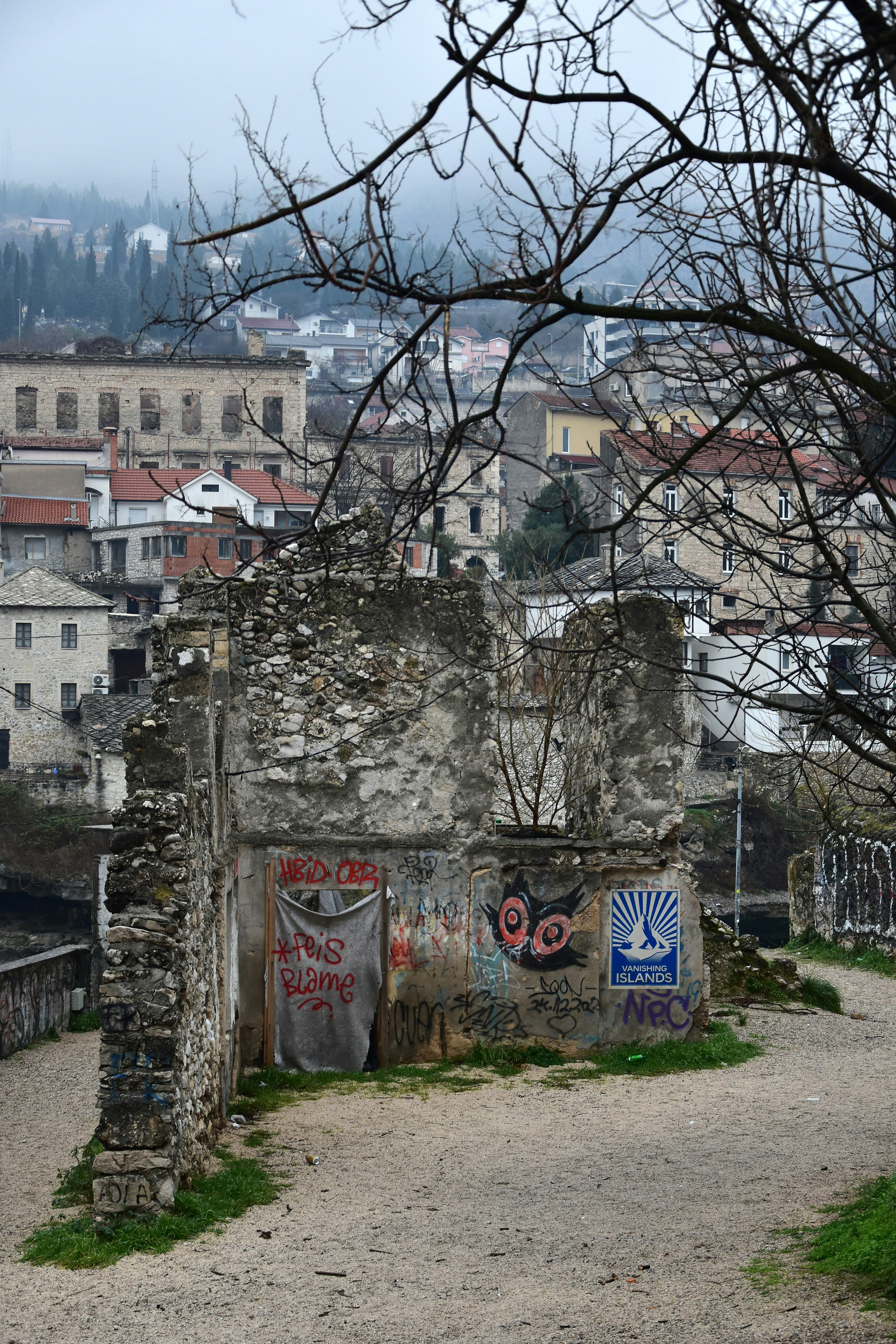 Ruined Wall Overlook: Graffiti and Townscape in Fog
