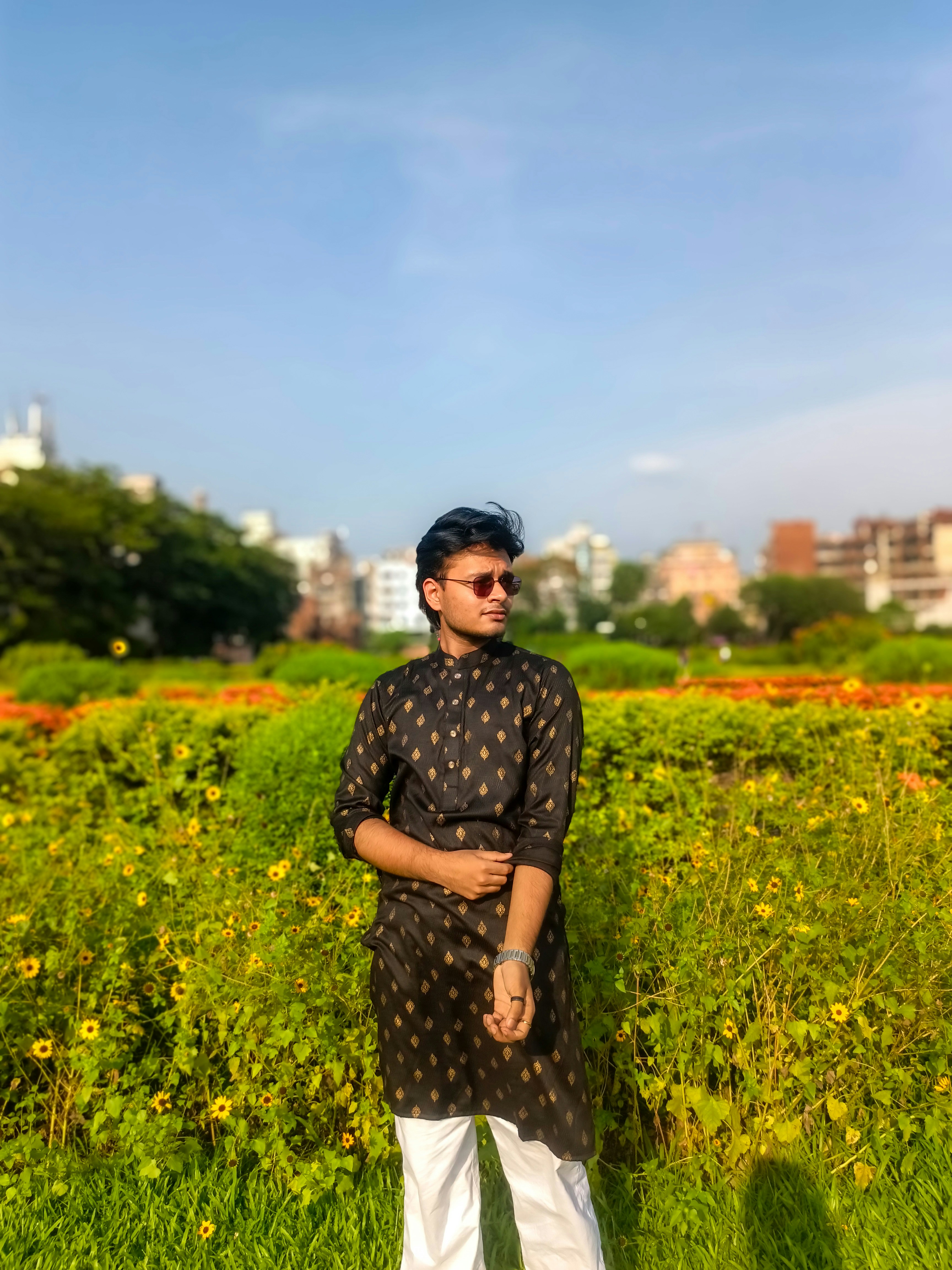 Field of Style: A Man in a Patterned Kurta Among Sunlit Sunflowers