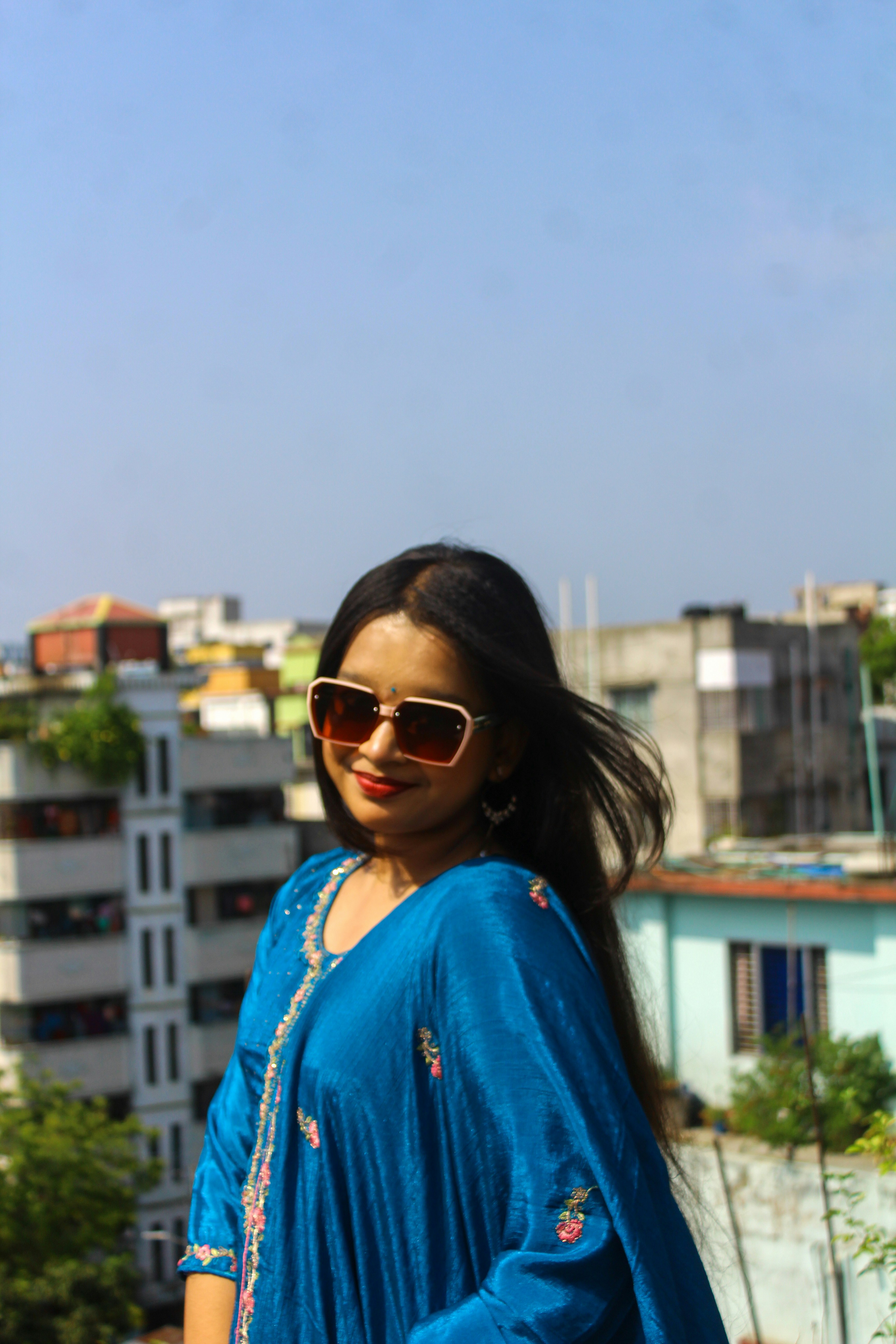 Blue-silk Confidence: A Woman in the City Sky