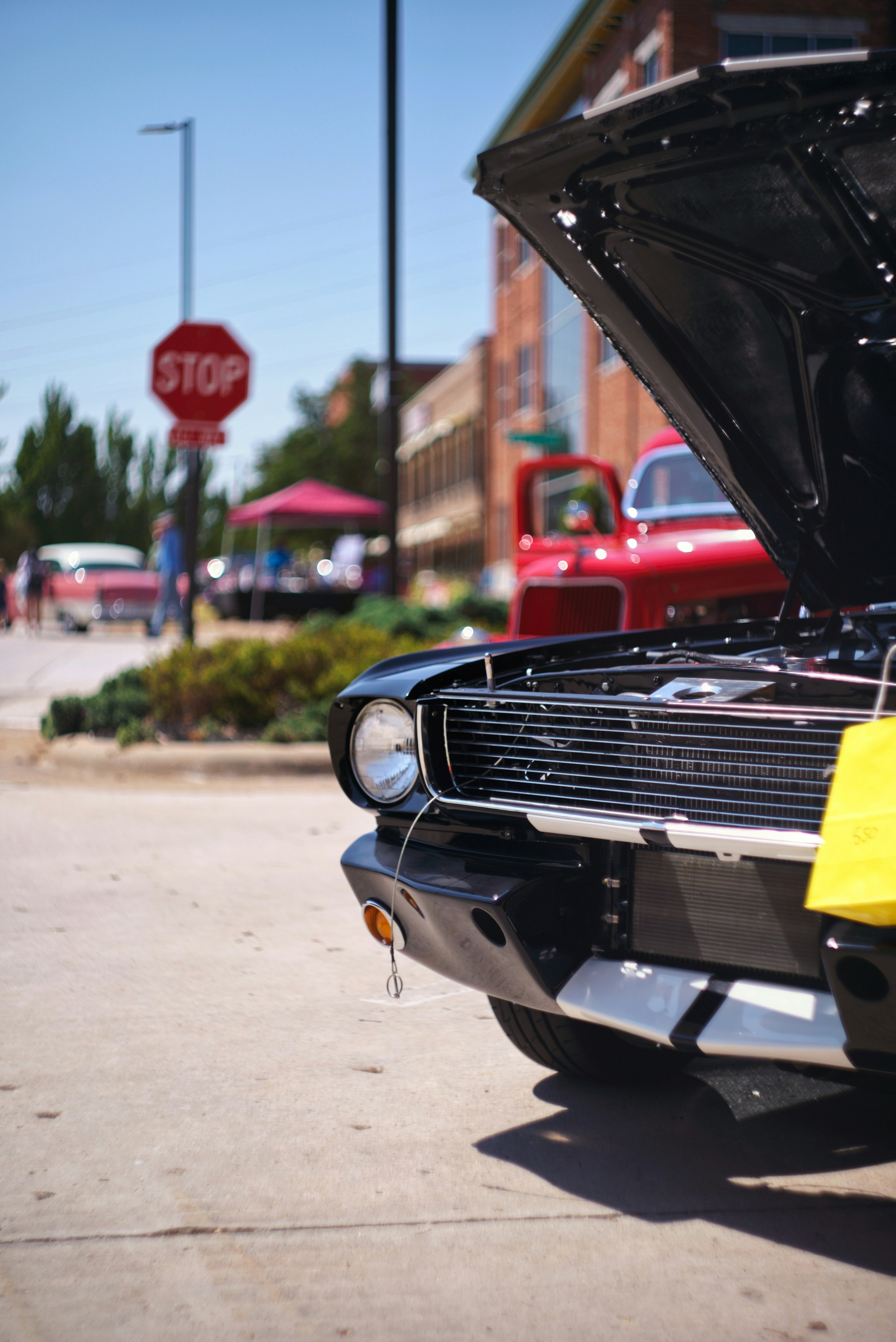 Front Grill and Hood Open: Classic Car Spotlight at a Town Street fair