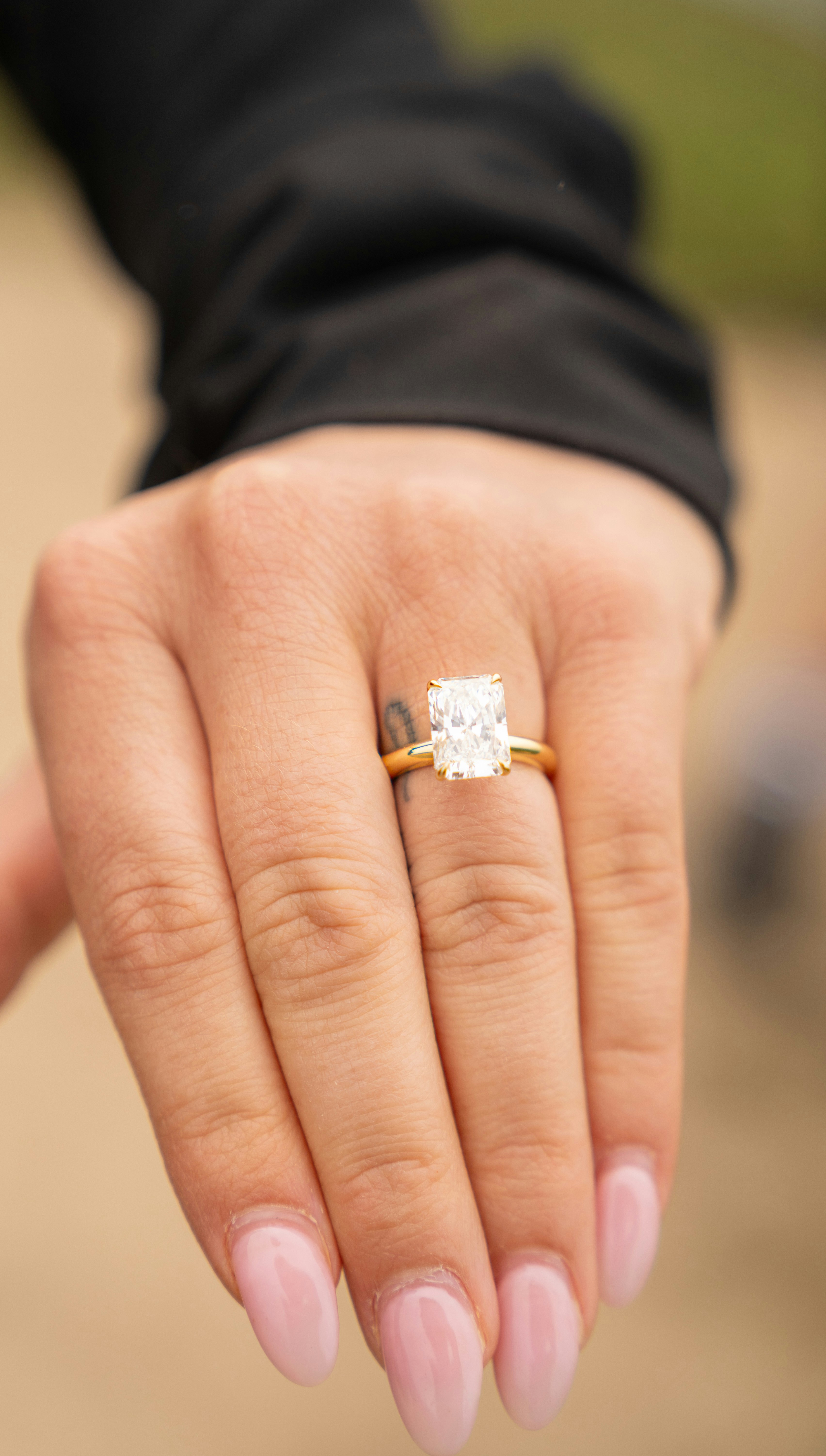 Solitaire Spotlight: The Emerald Ring on a Gentle Hand