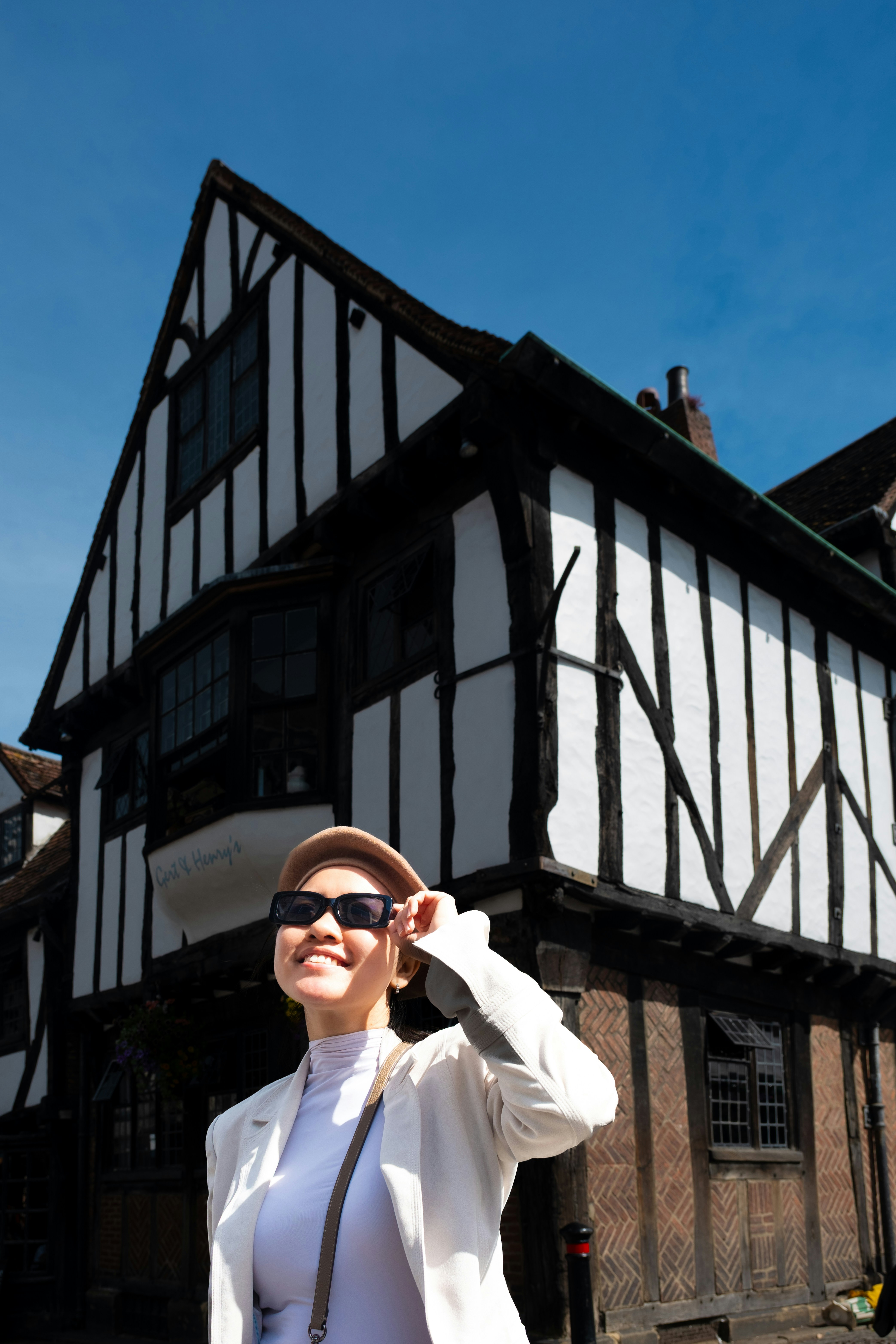 Smiling Tourist in Front of a Tudor-Style Fachwerk House
