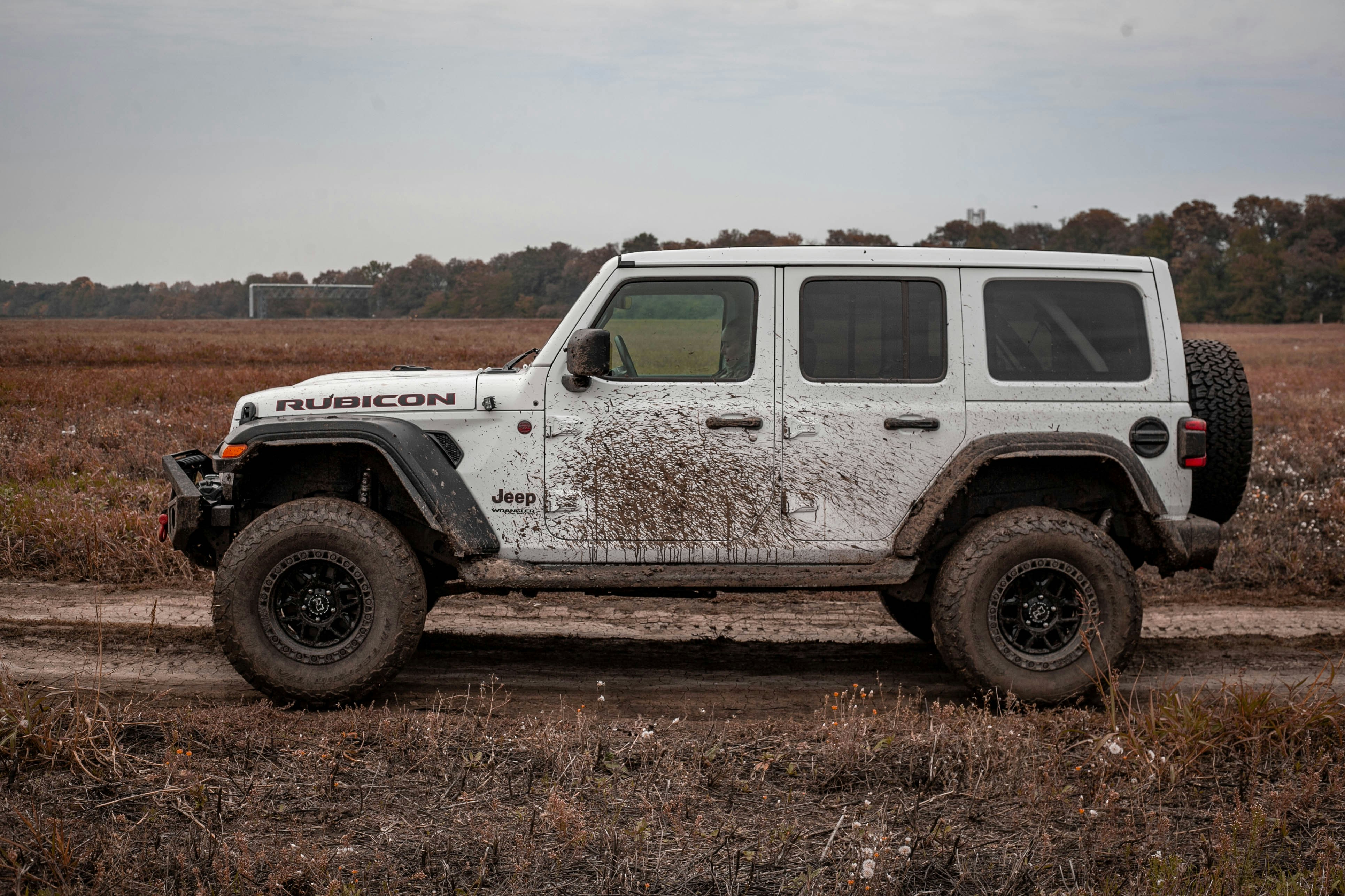 Mud-Splattered Jeep Rubicon in a Field Ride
