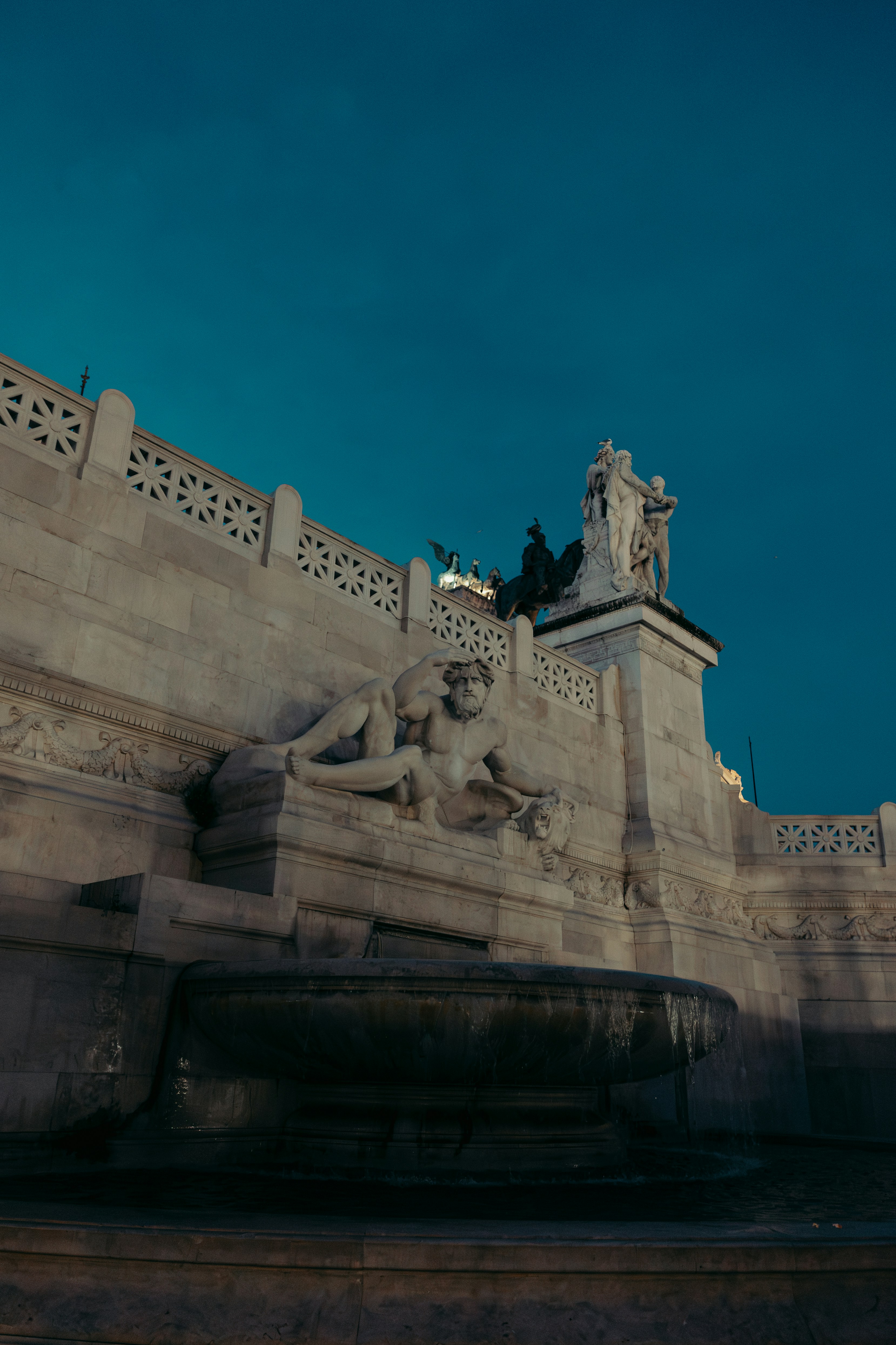 Stone Serenity: A Moonlit Fountain and Reclining Muse