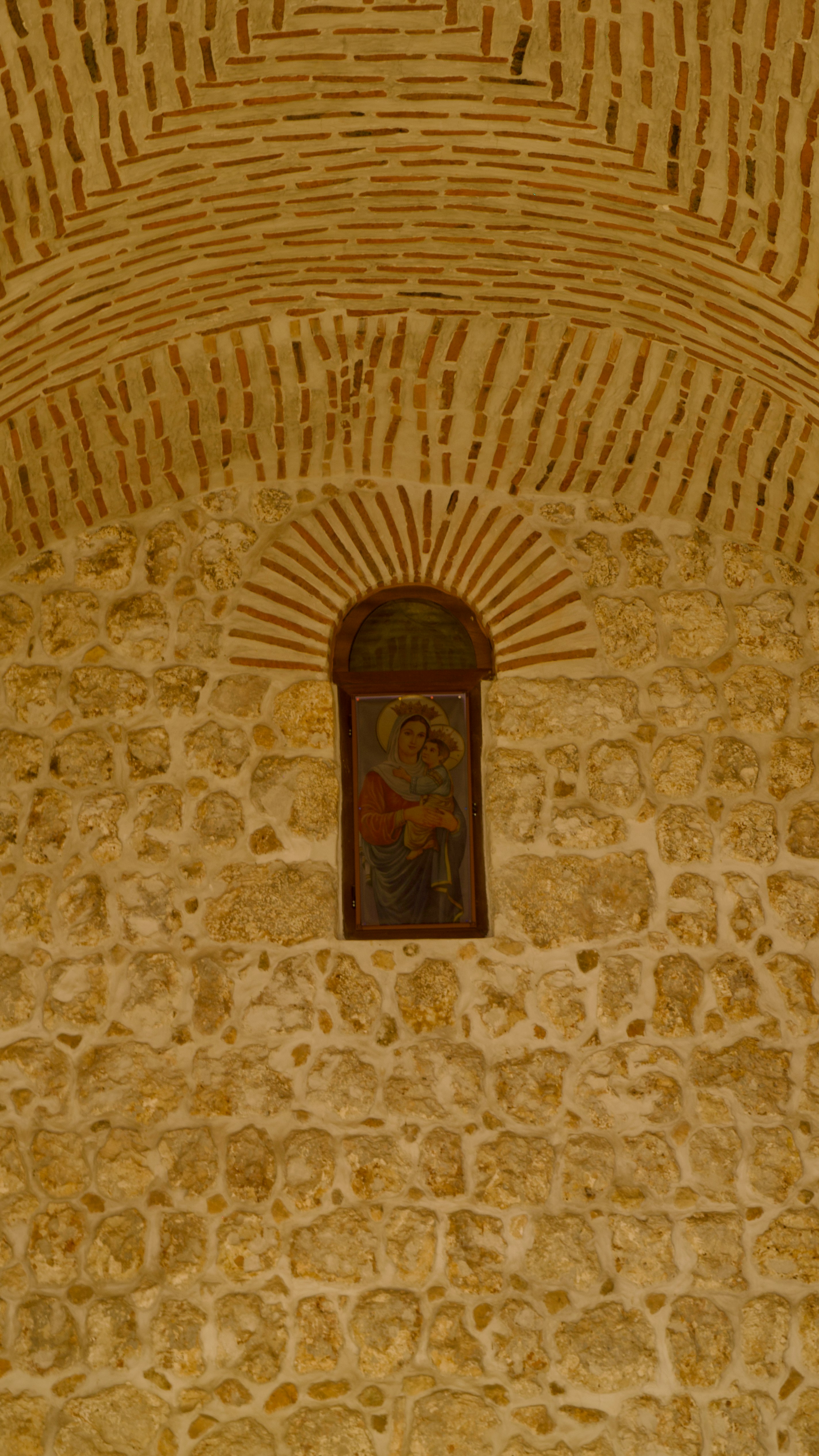 Hidden Mosaic of Light: Saintly Window in Stone Arch