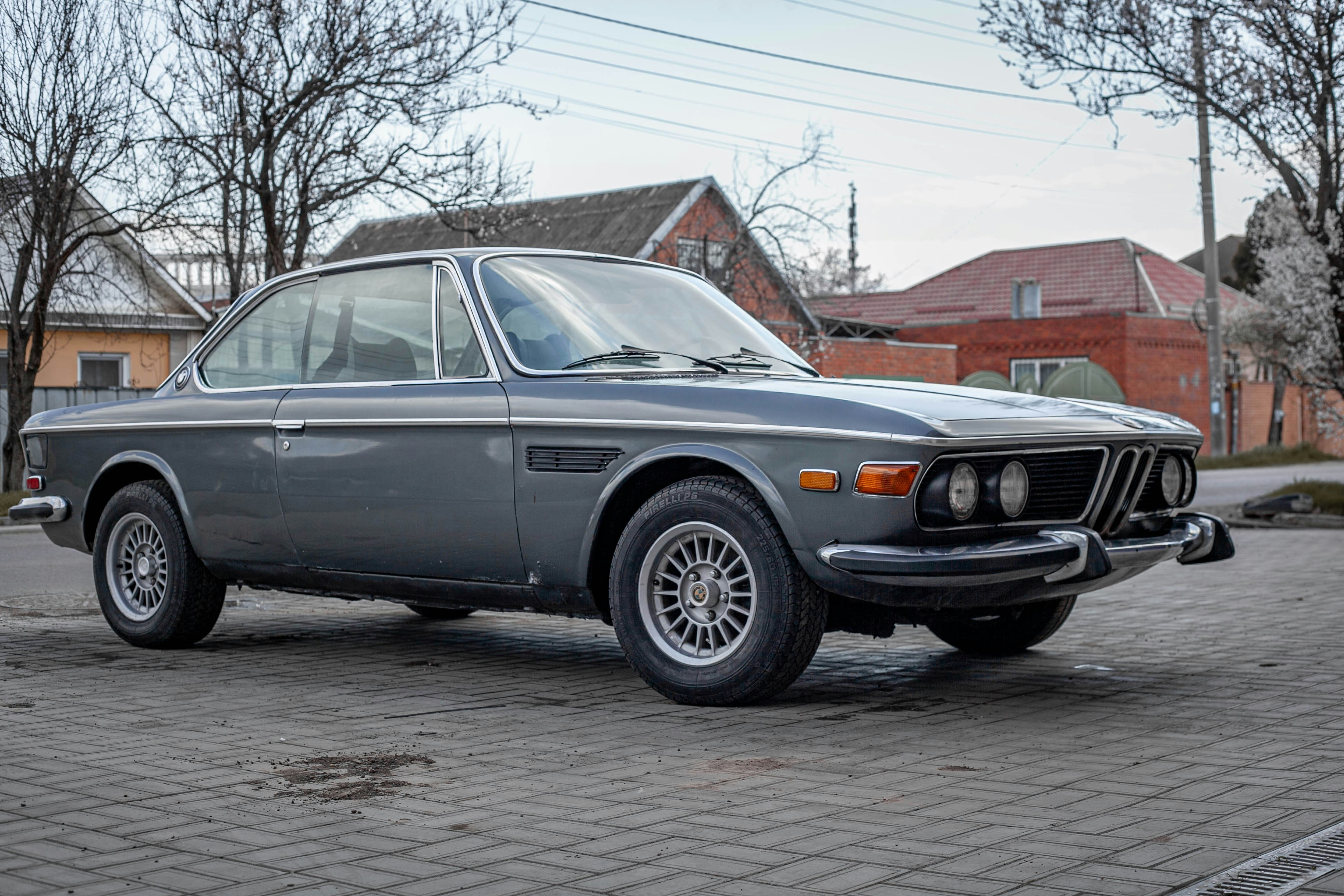 Vintage Turquoise BMW on a Quiet Brick Street