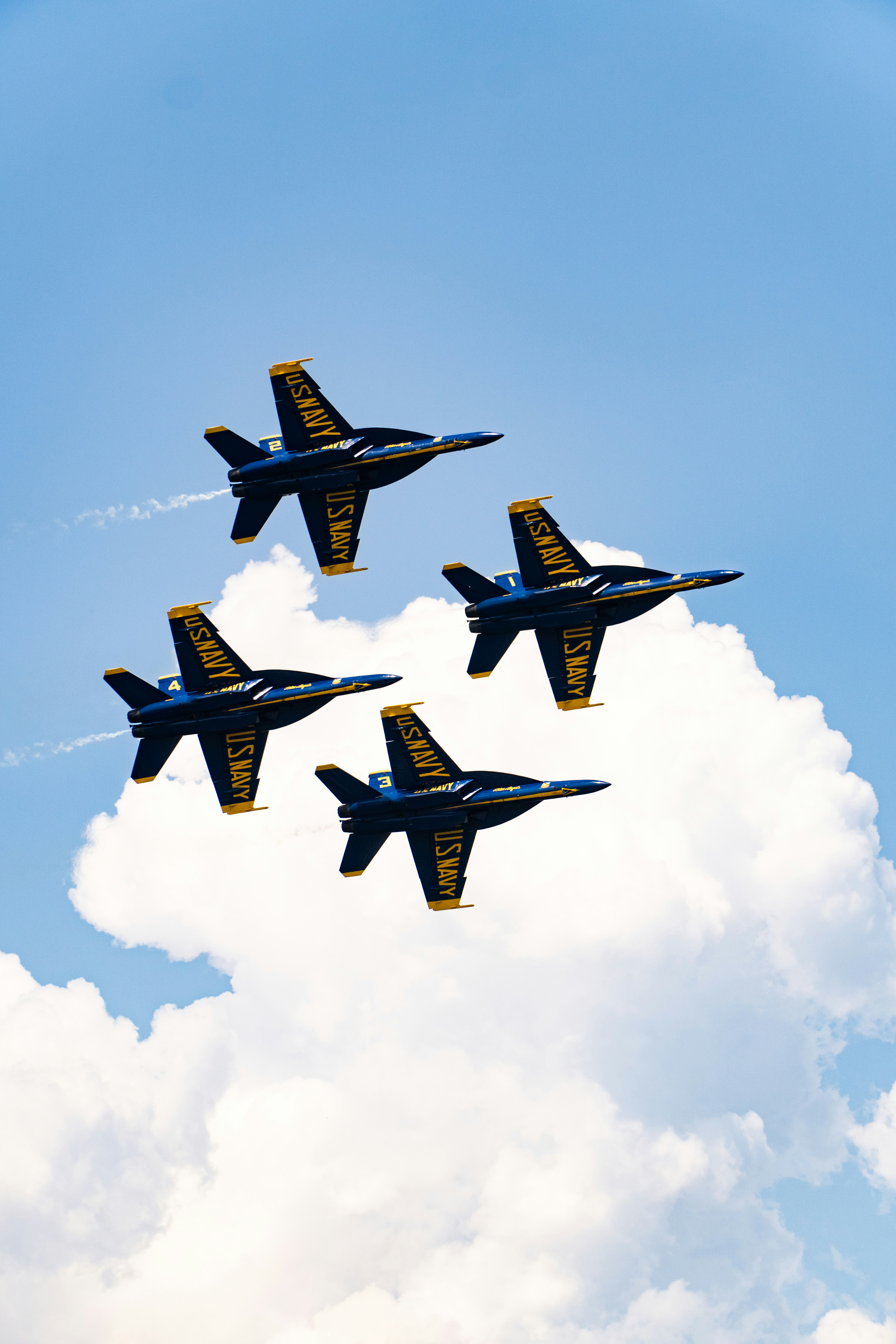 Five Blue Angels Cut Through a Bright Sky Over a Puffy Cloud