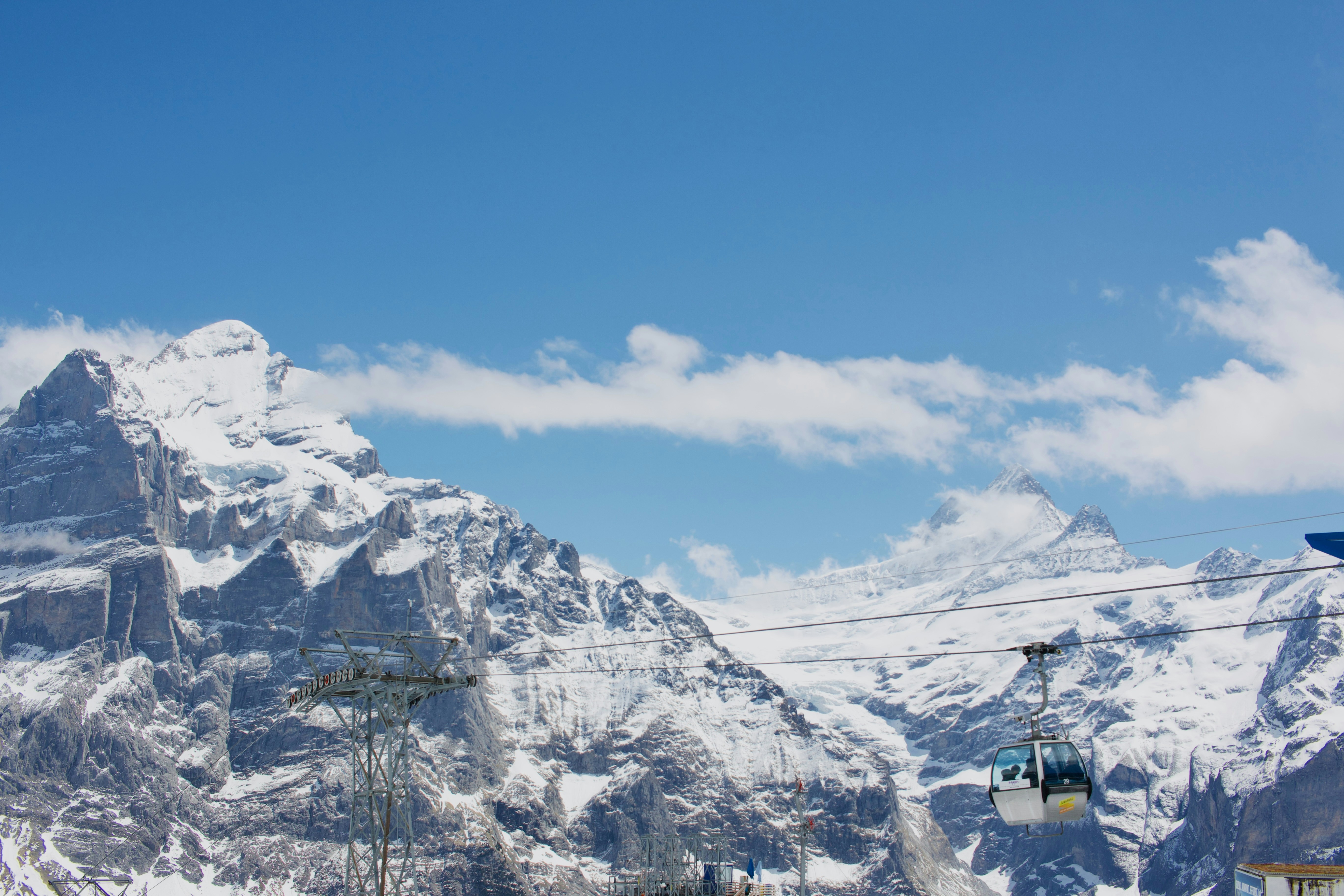 Cable Car Against Alpine Crests at Bright Noon