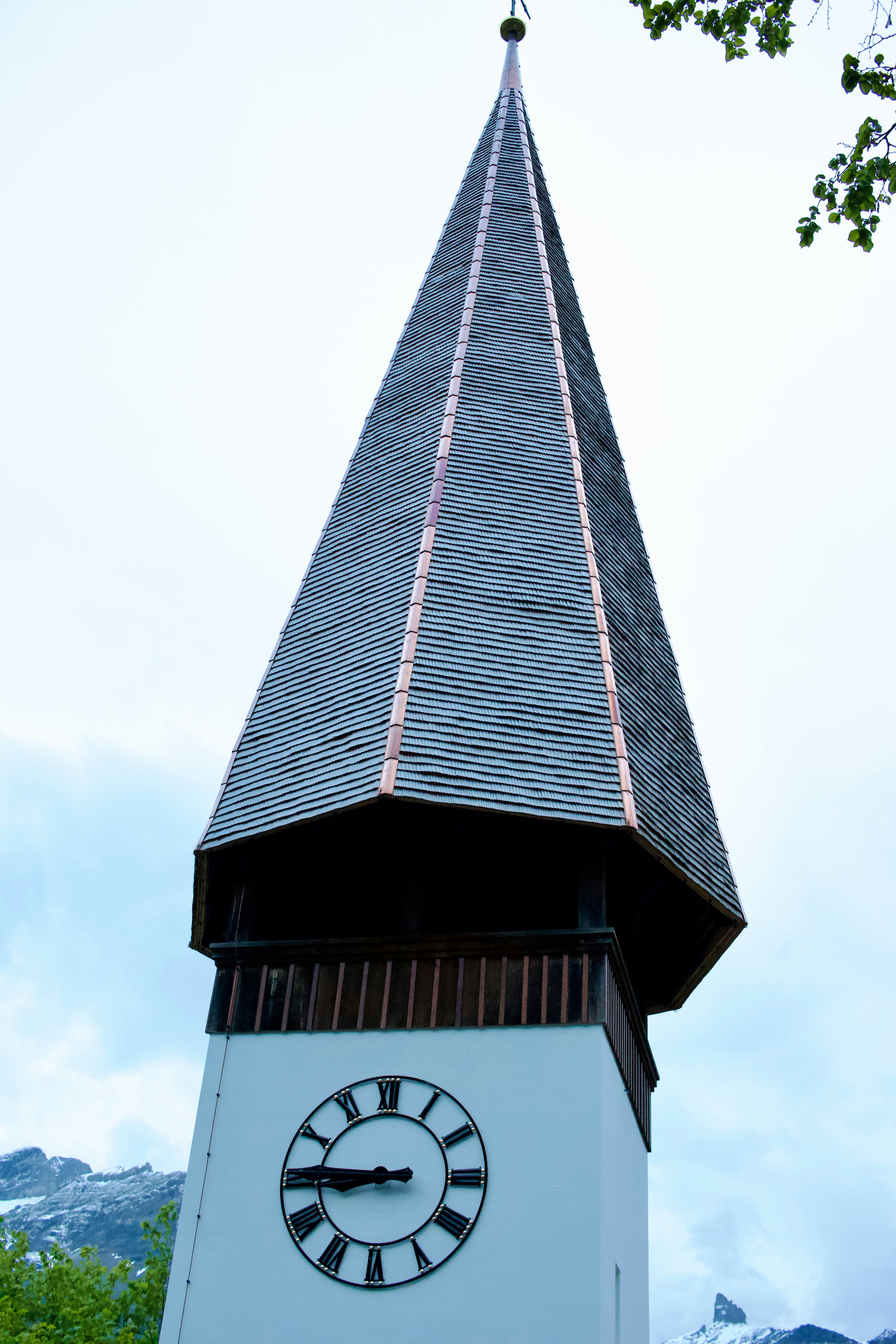 Spire Ascending: Clock Tower Beneath a Tapered Timber Peak