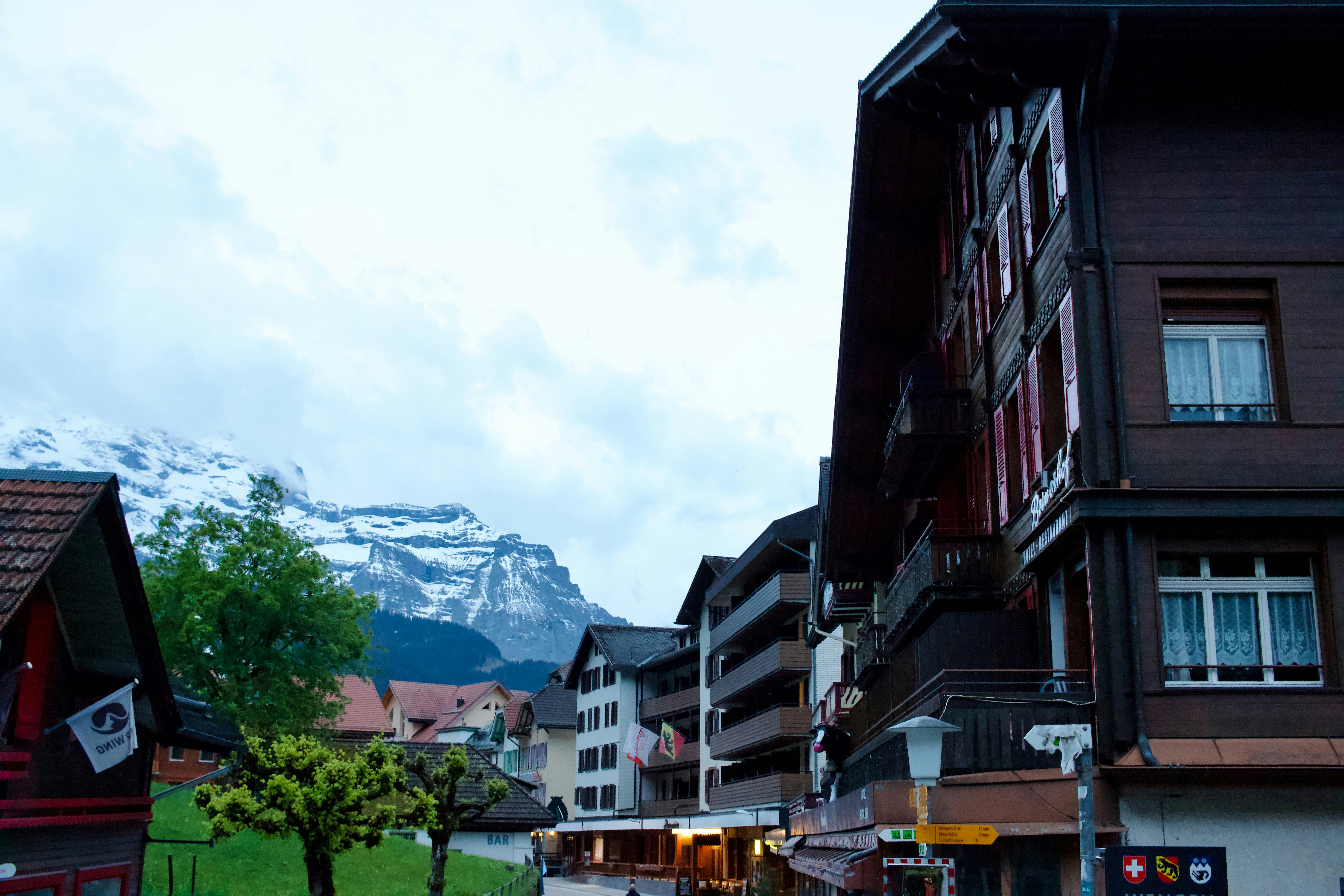 Alpine Village Facade Amid Snow-Capped Peaks at Dusk