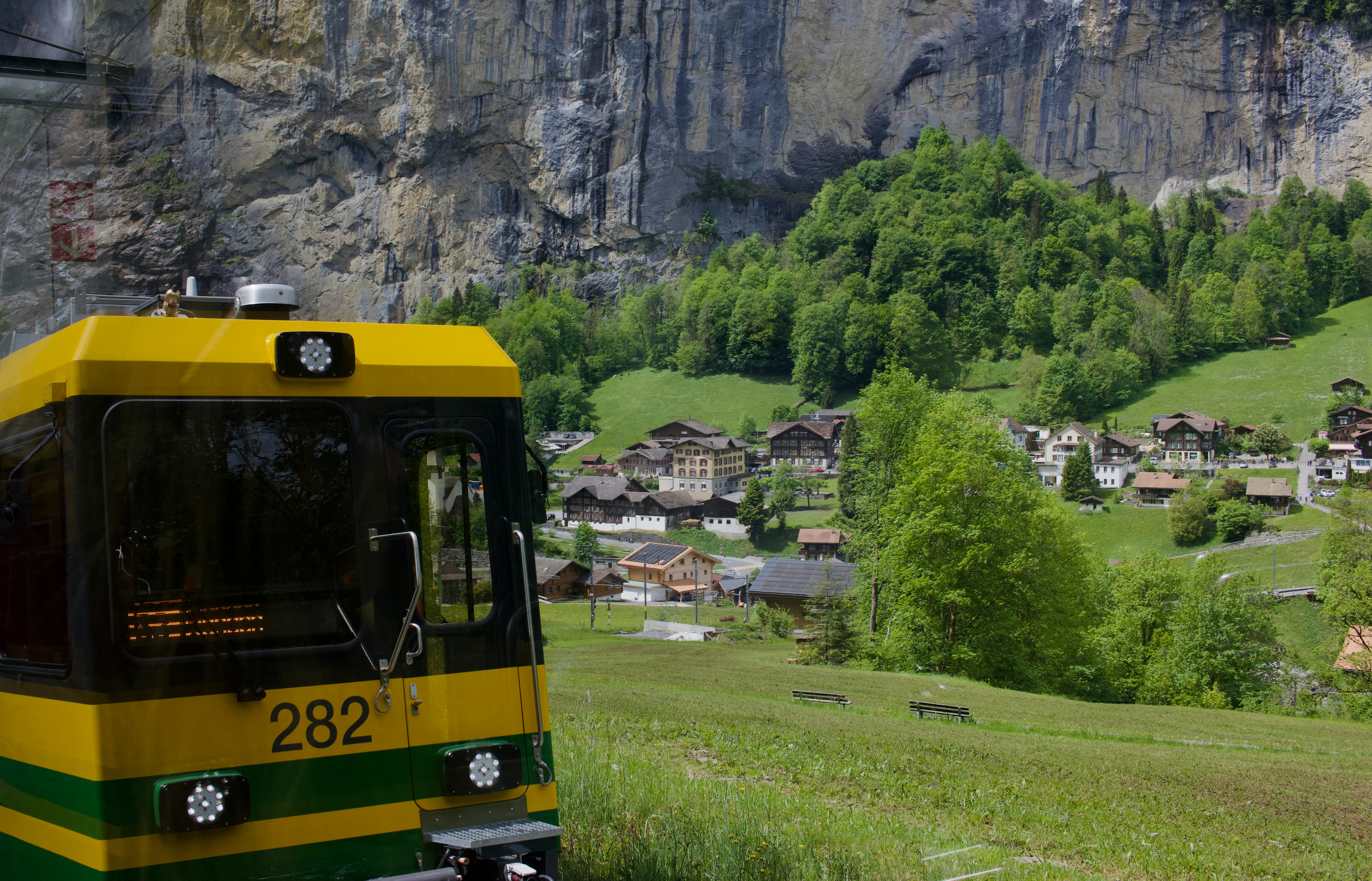 Yellow locomotive at the hillside village edge