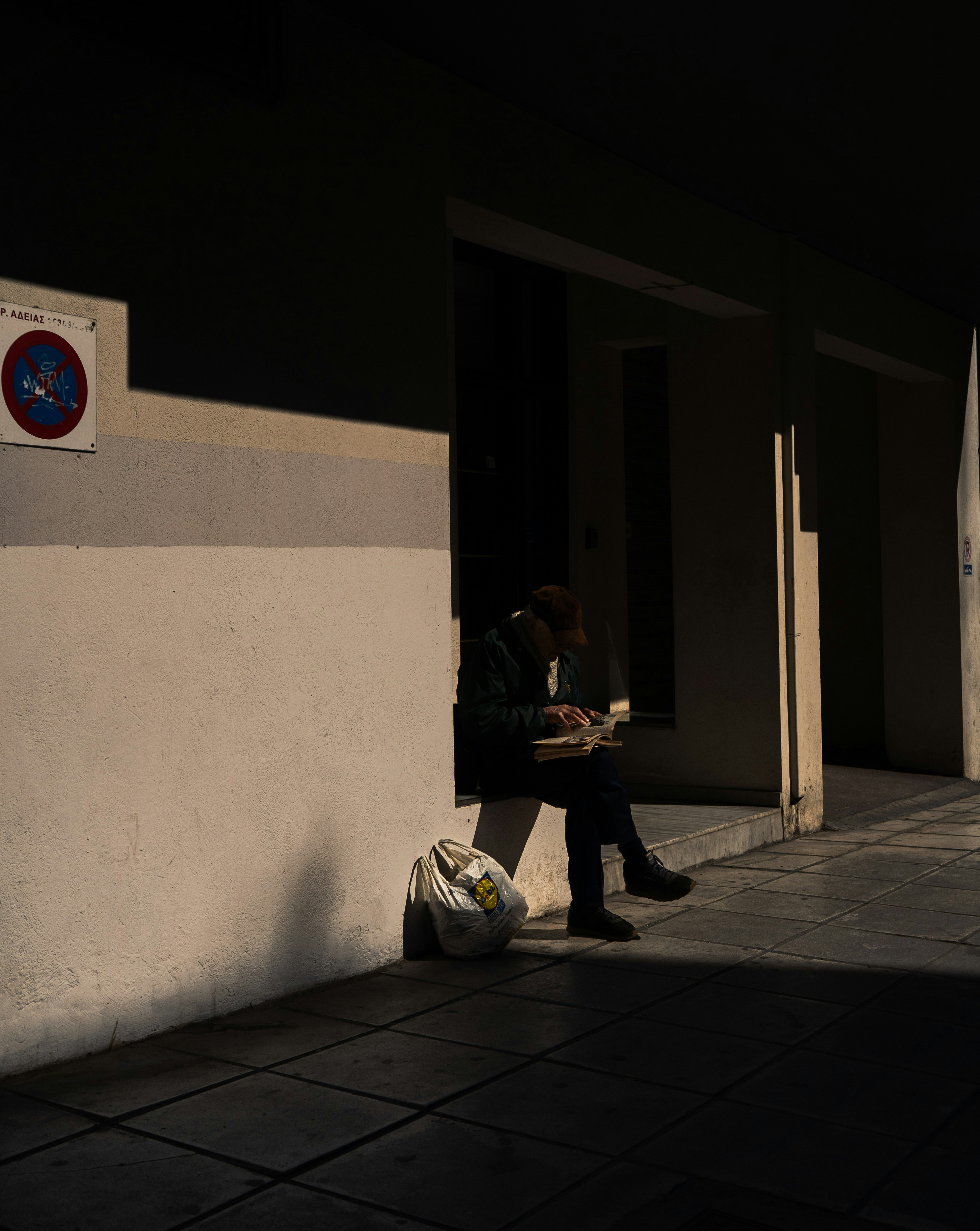 Lonely Reader in Shadowed Archway
