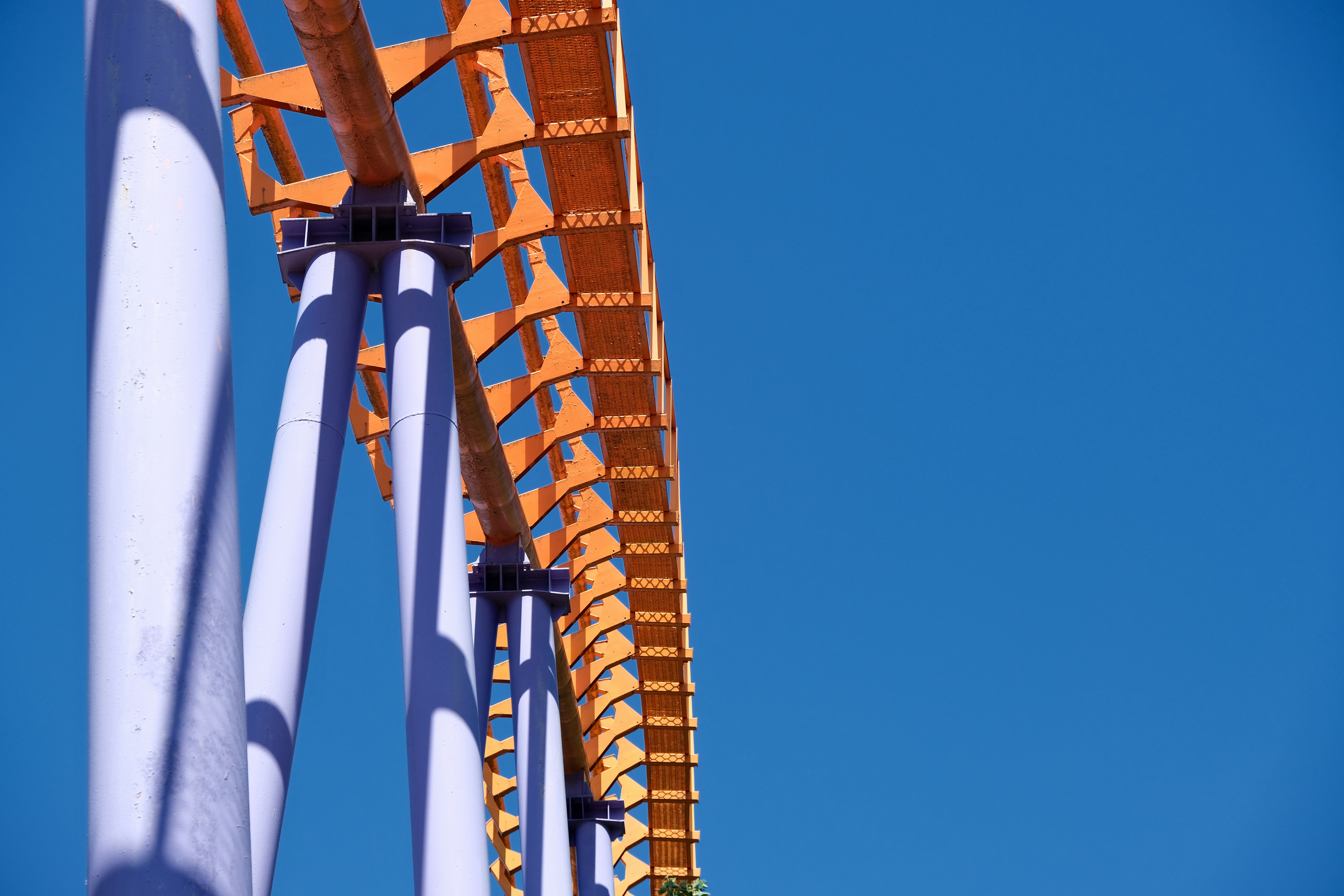 Blue pillars march into a crisp, cloudless blue sky