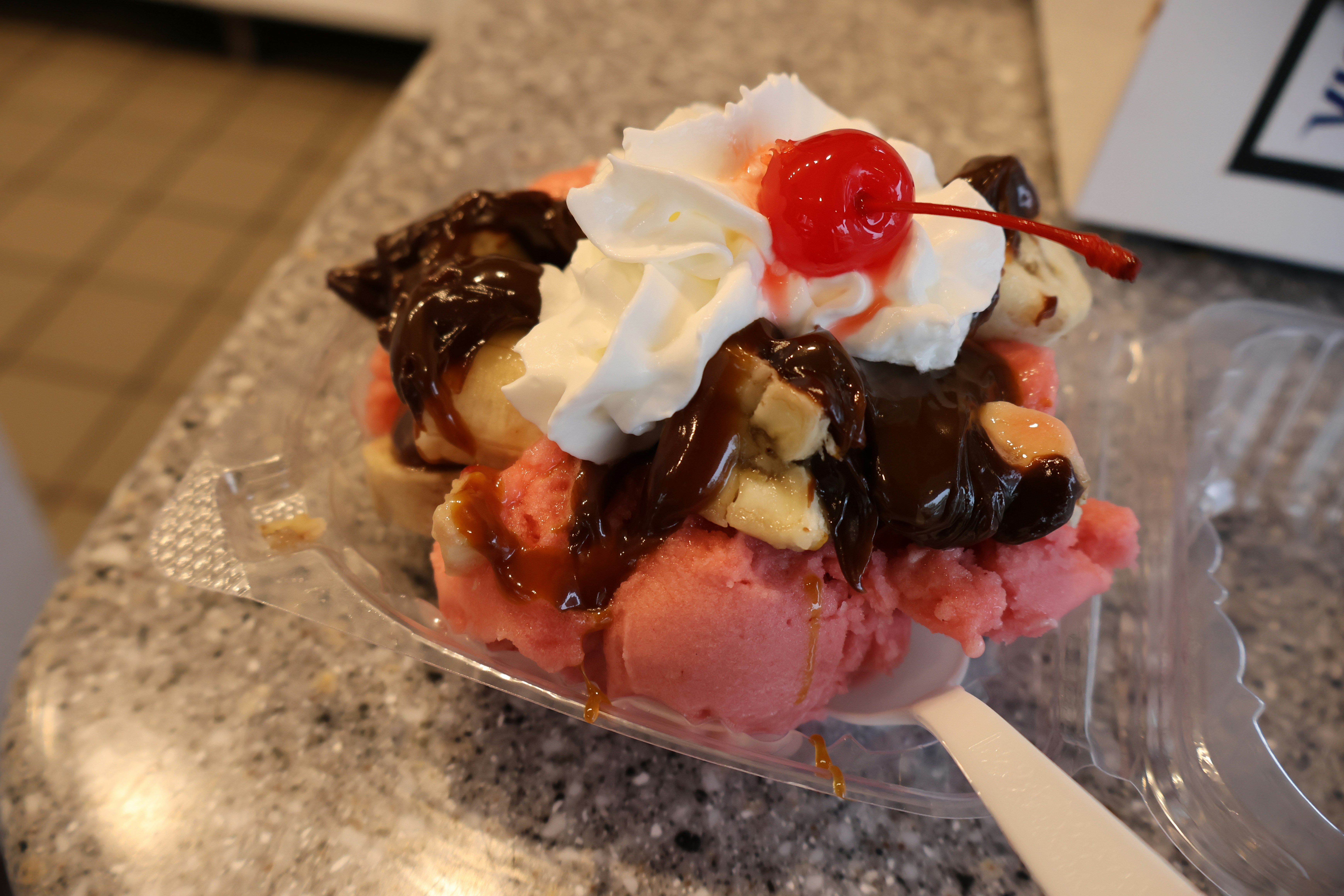 Sweet Summit: A Scoop Crowned with Whipped Cream and Cherry