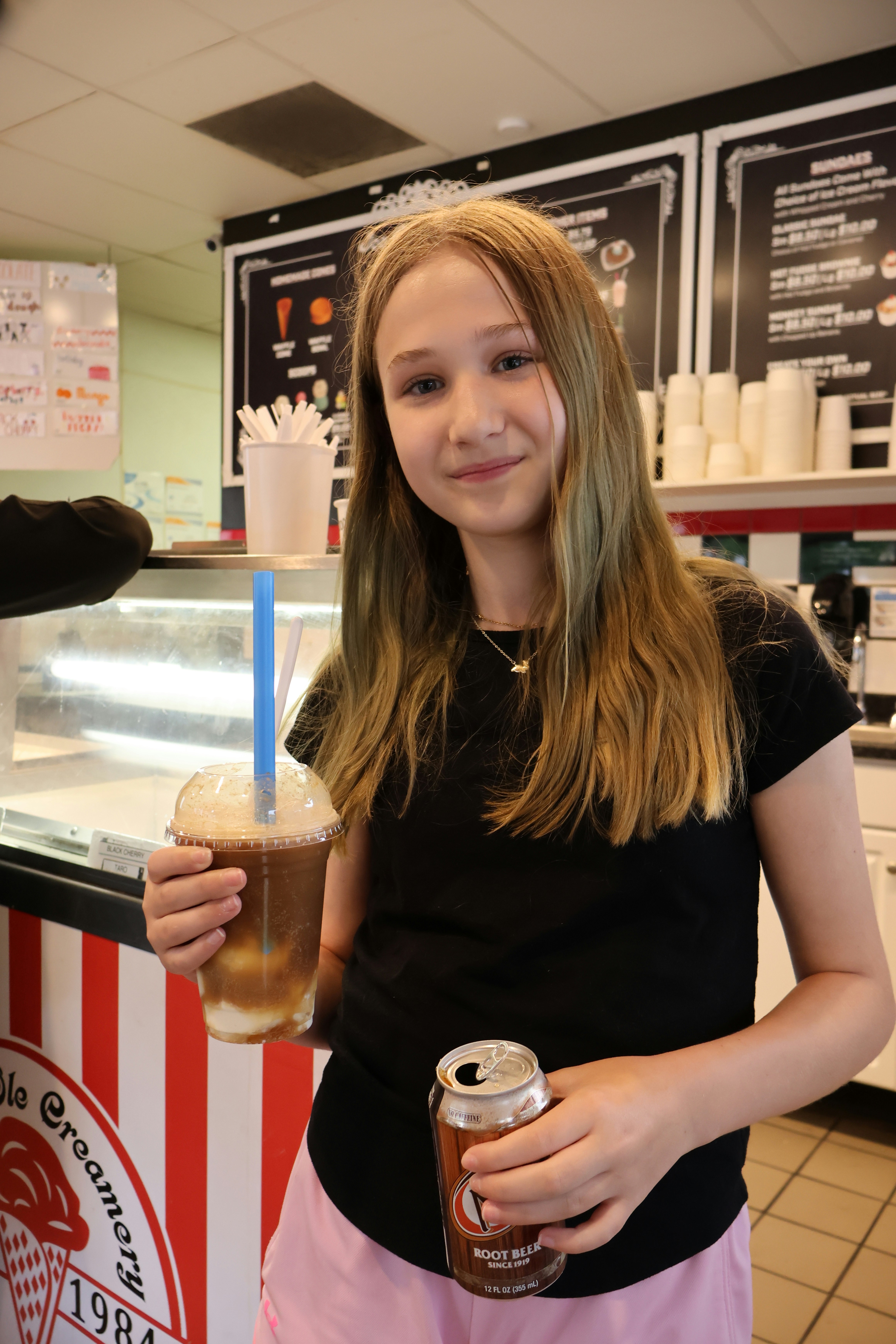 Cafe Portrait: Smiling Attendant with Icy Drink