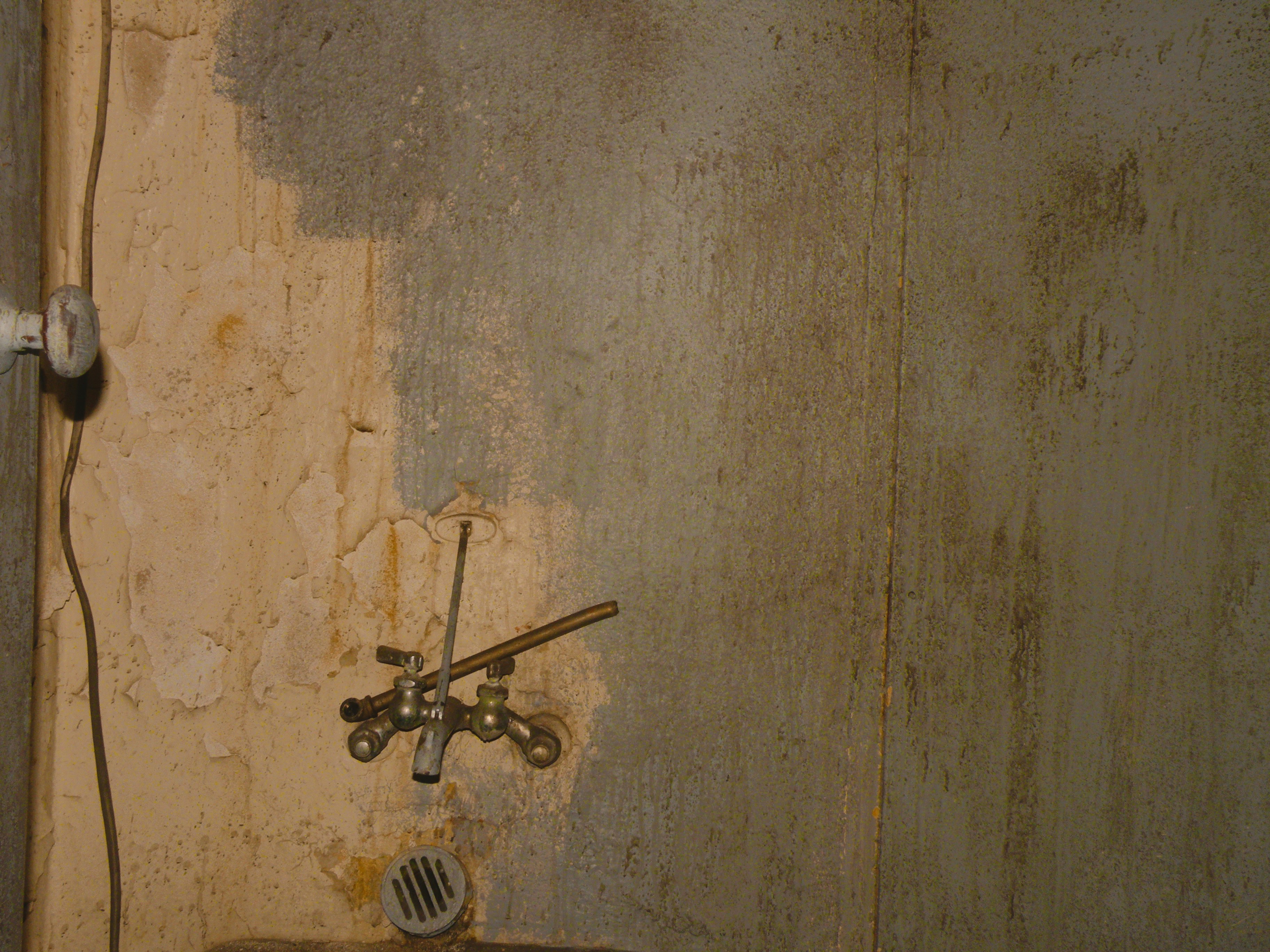 Faucet in a weathered cellar: a quiet, neglected corner