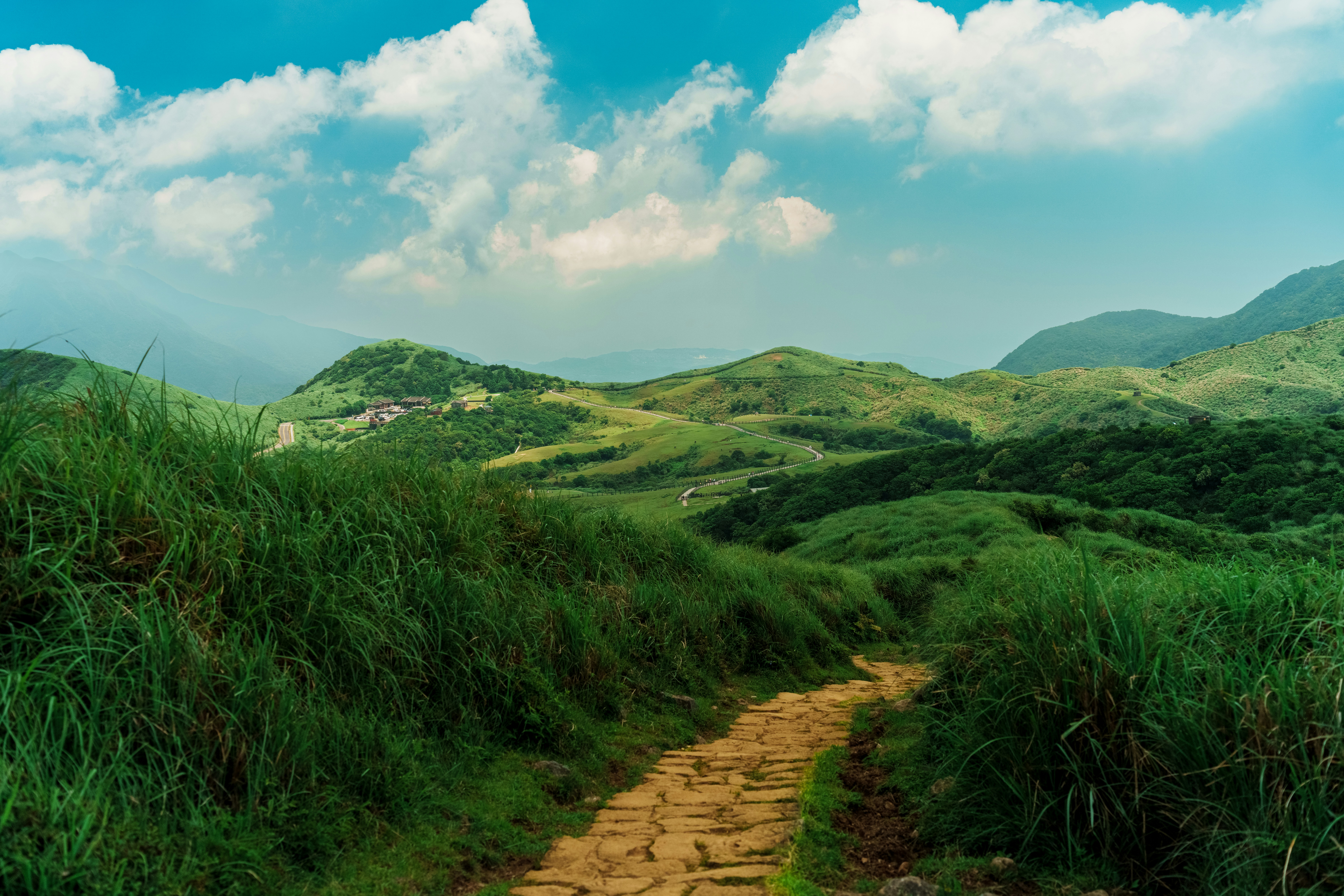 Footpath Through Emerald Hills: A Quiet Ascent to the Distant Summit