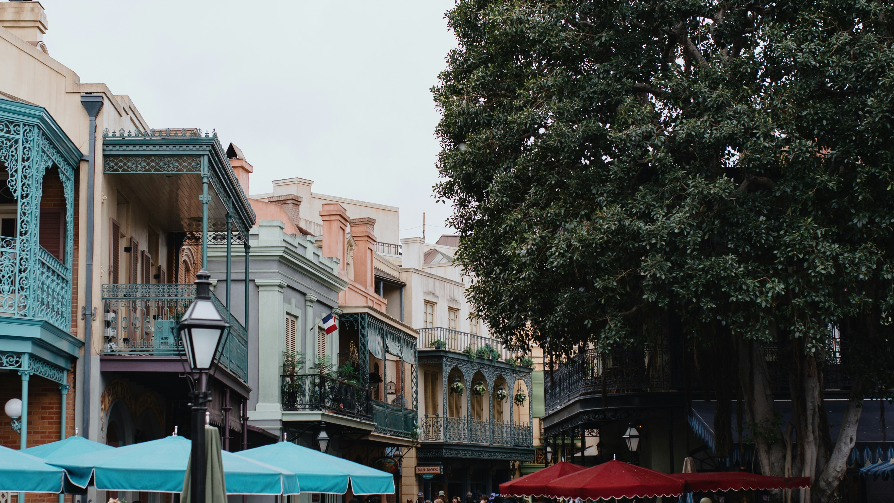 Pastel Row and Teal Ironwork Along a Sunlit Street