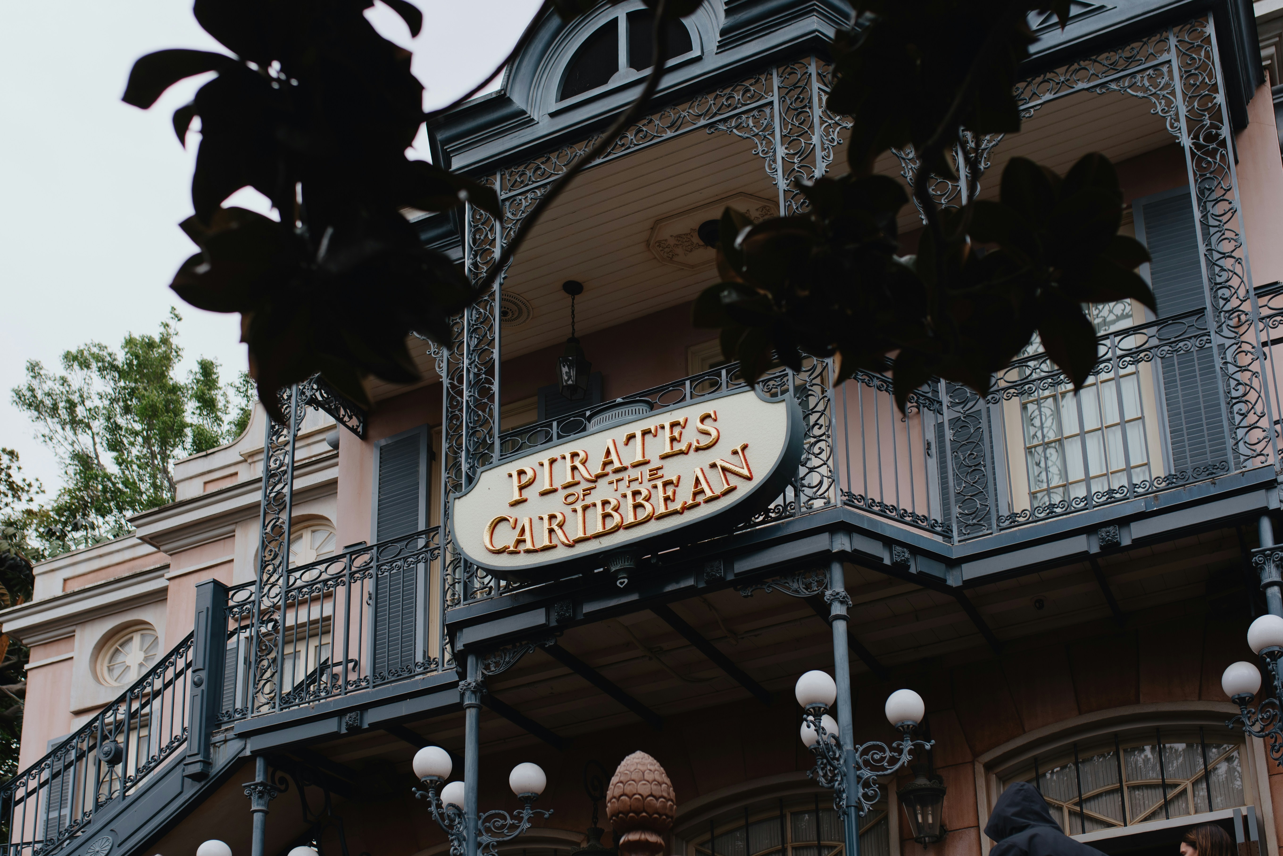 Caricatured Balcony Heritage: Pirates & Caribbean Sign on a Victorian Facade