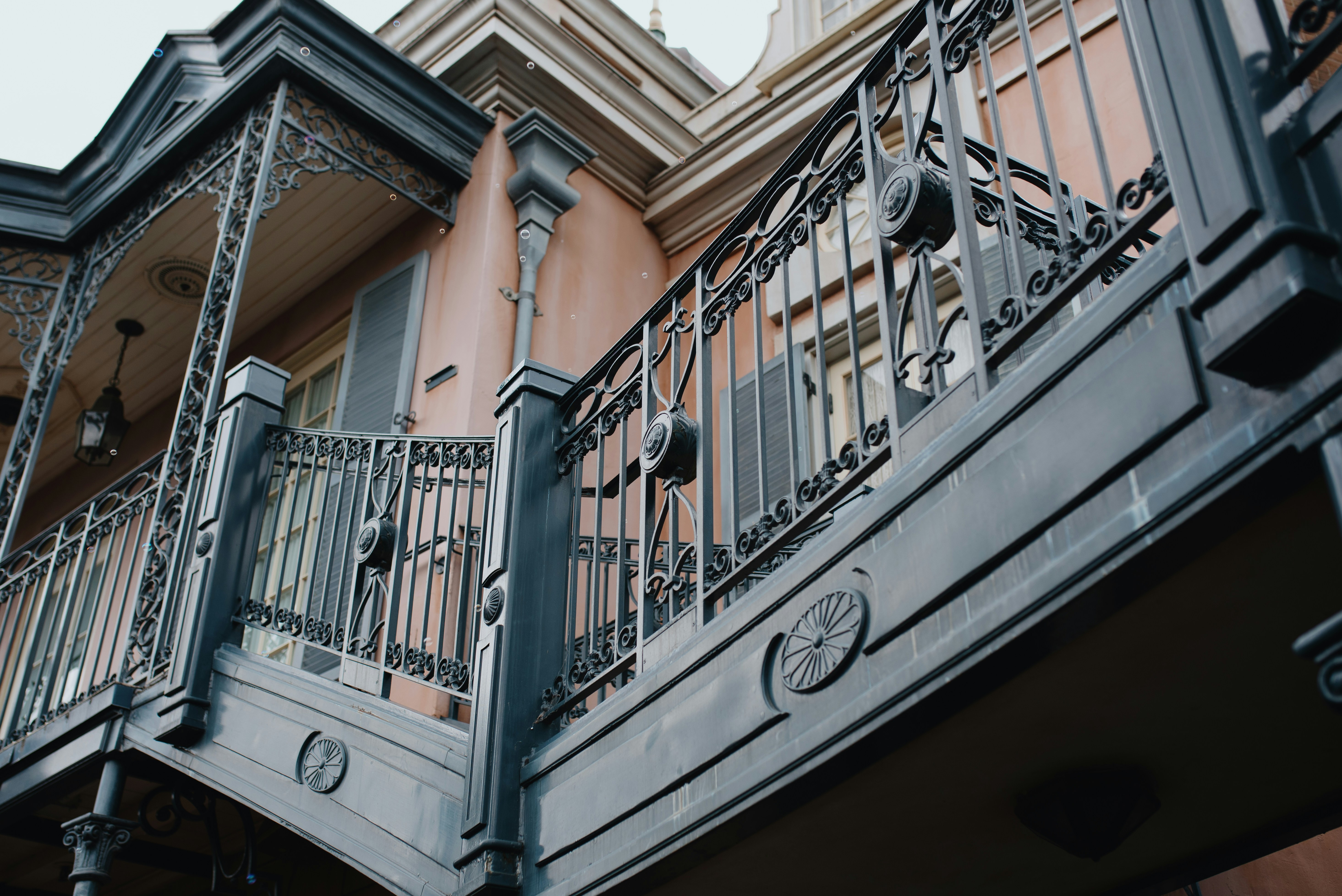 Ornate Balcony Ironwork Framing a Peach Facade