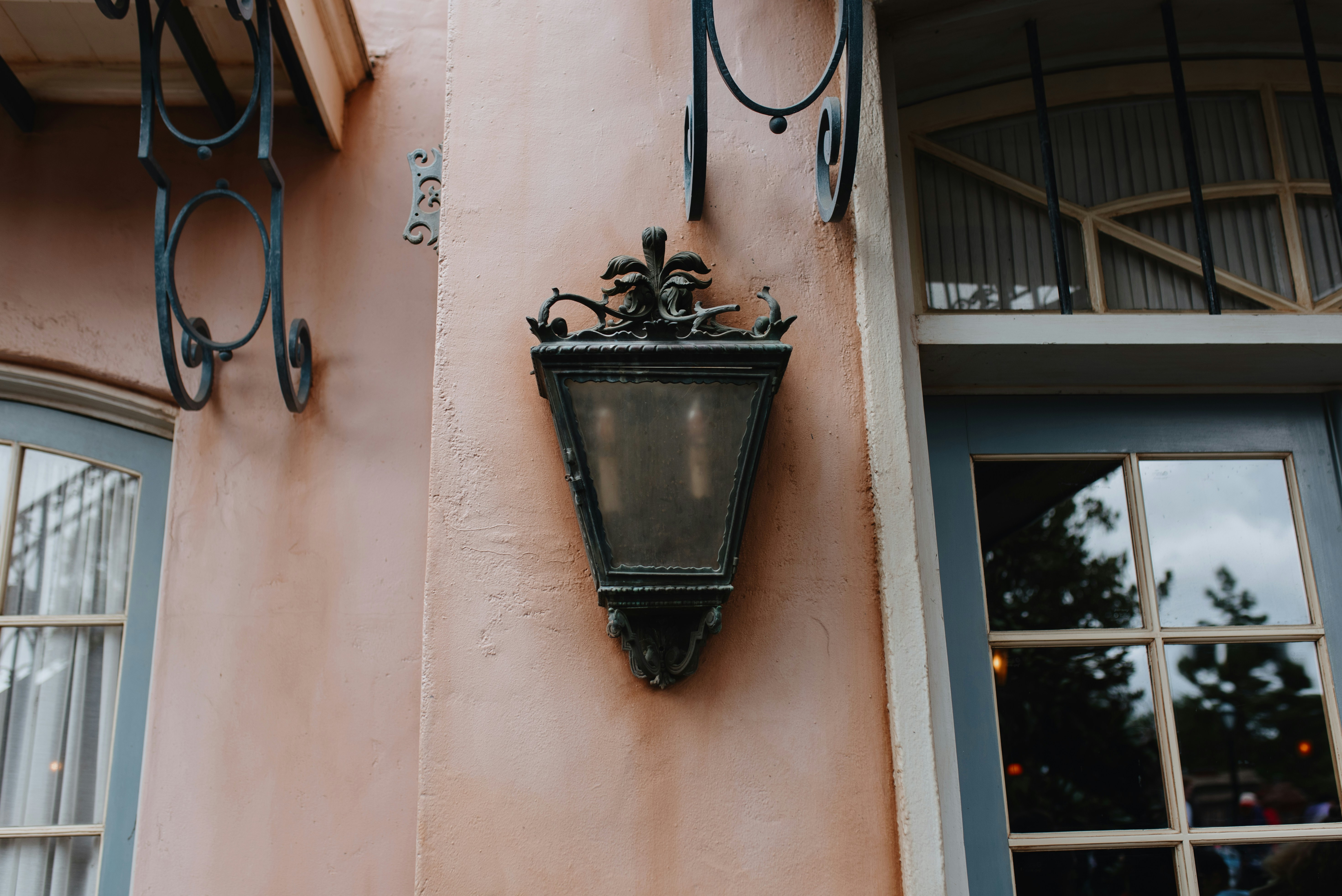 Ornate Street Lantern Framed by Peach Wall and Windows