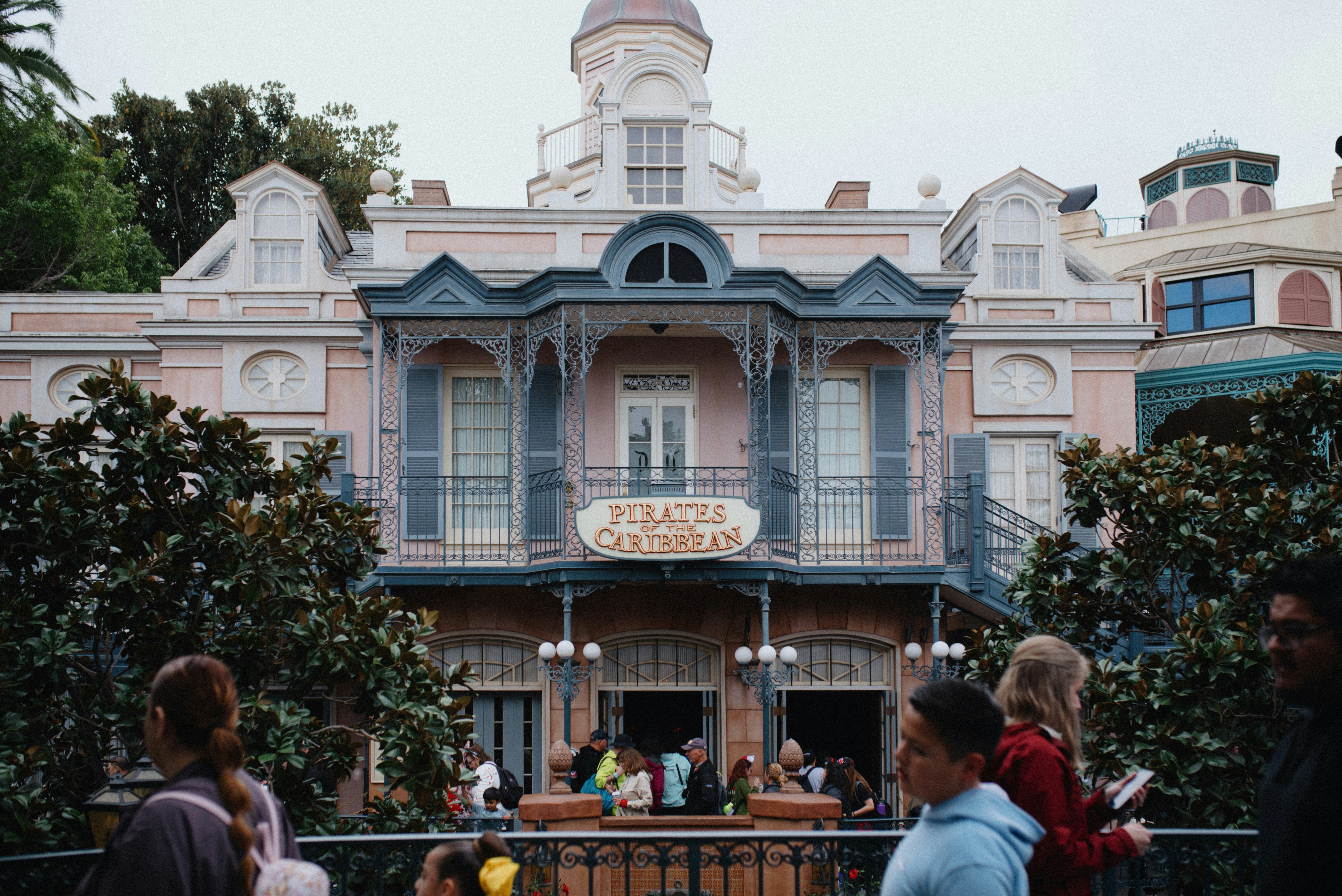 Pastel Facade Marvel: A Carousel of Guests at a Victorian Courtyard