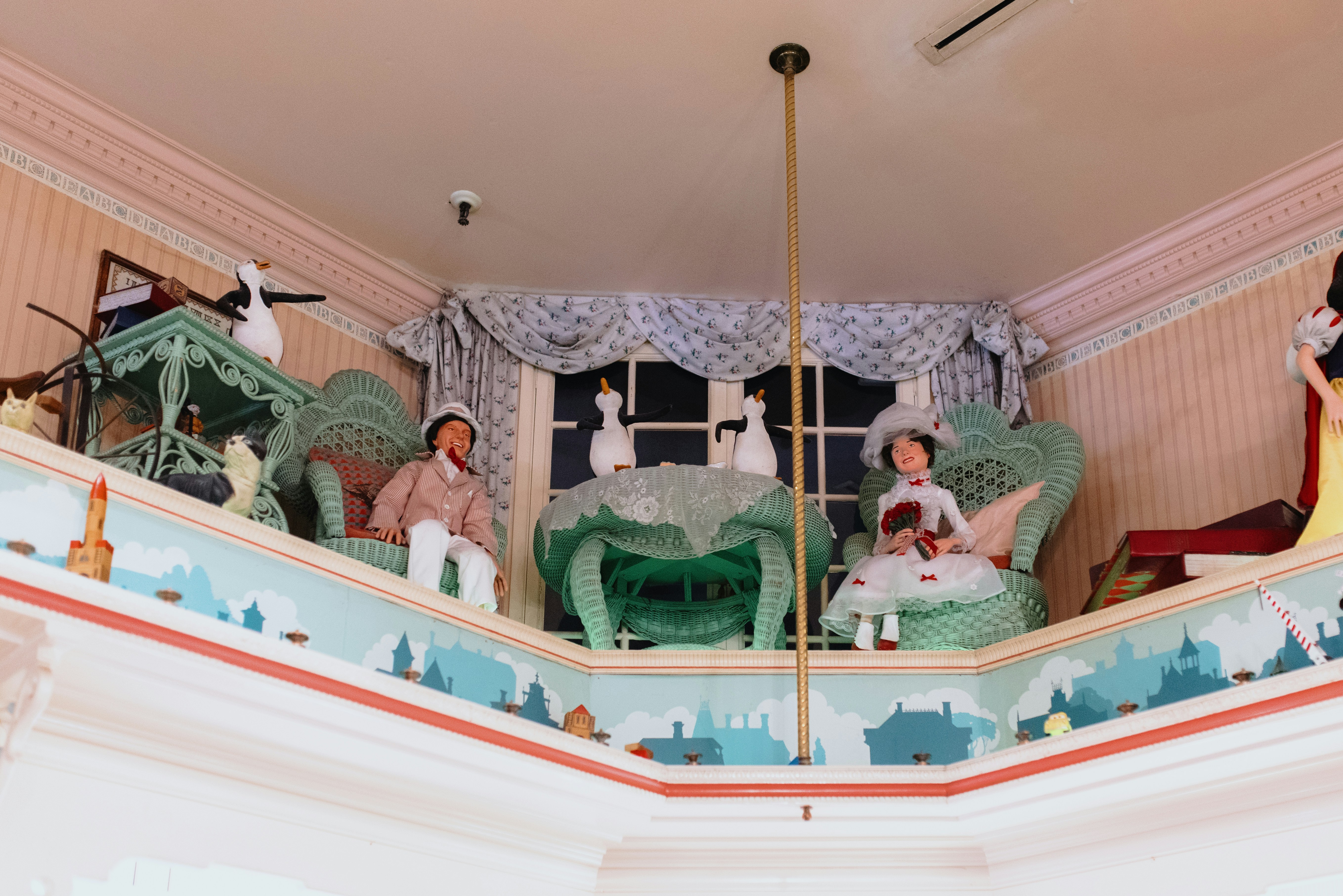 Balcony of porcelain dolls under a pastel canopy