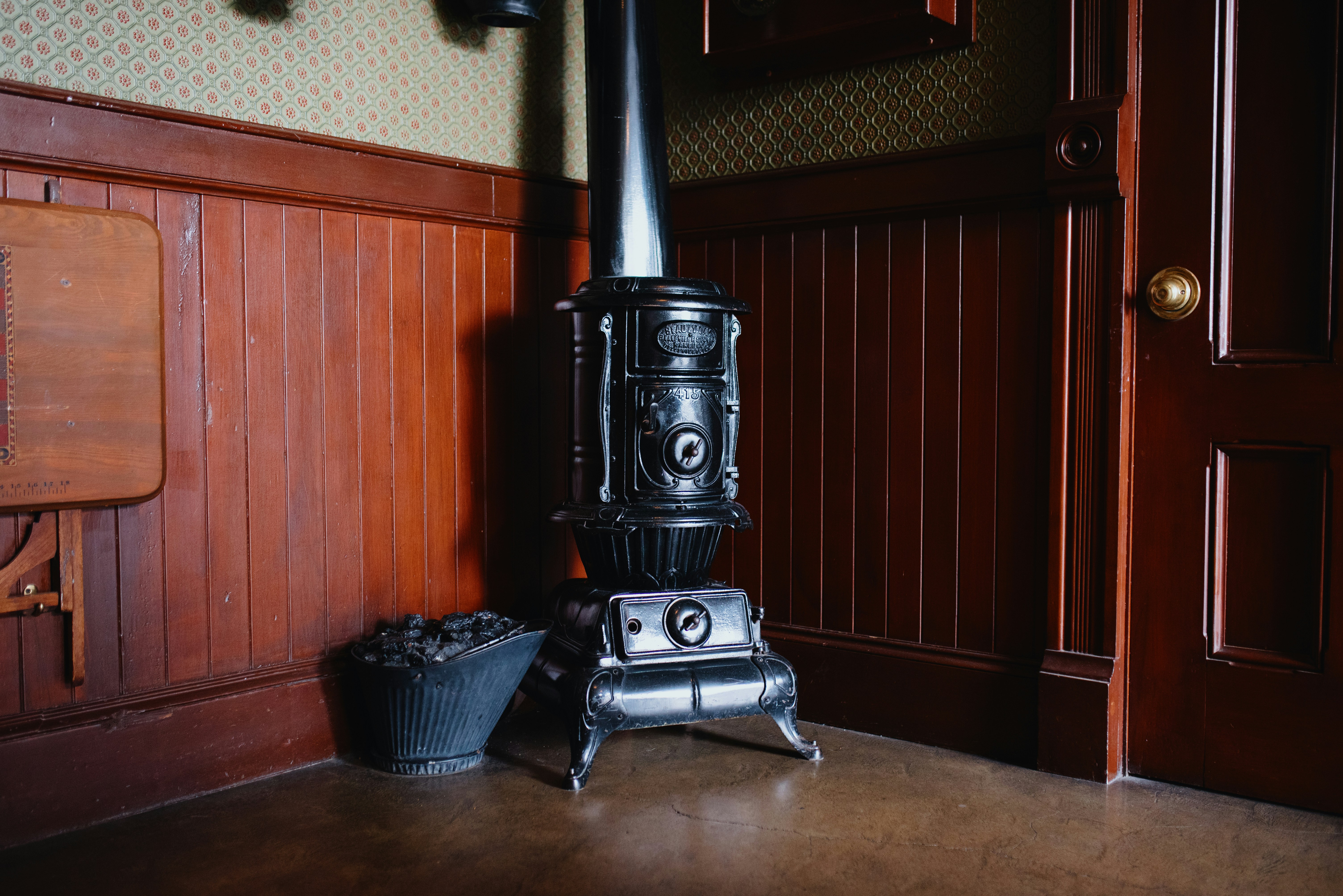 Cozy Corner Stovepipe: A Vintage Heater in a Woodbound Room