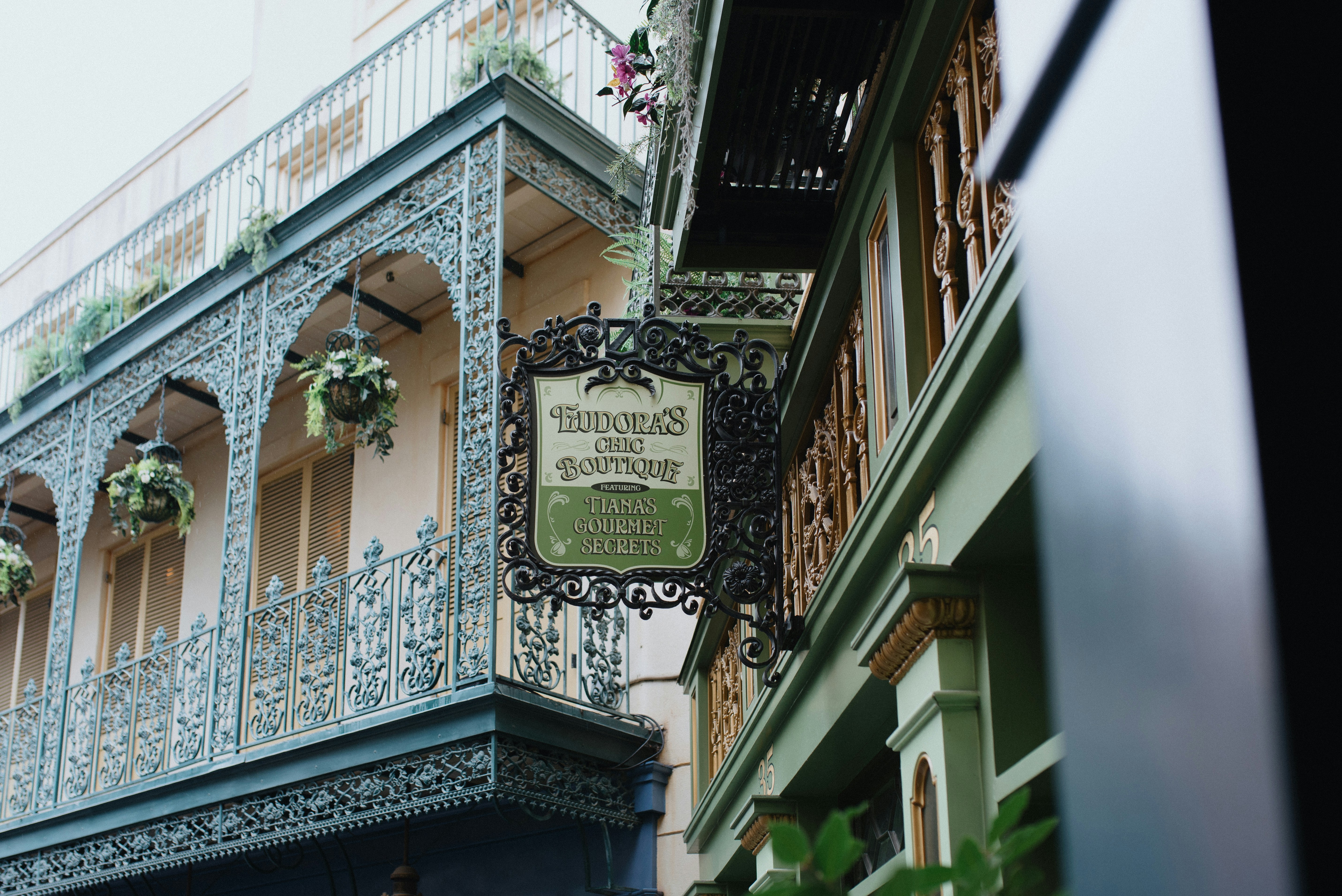 Ornate Cast-Iron Balcony Signage in a French Quarter Arcade