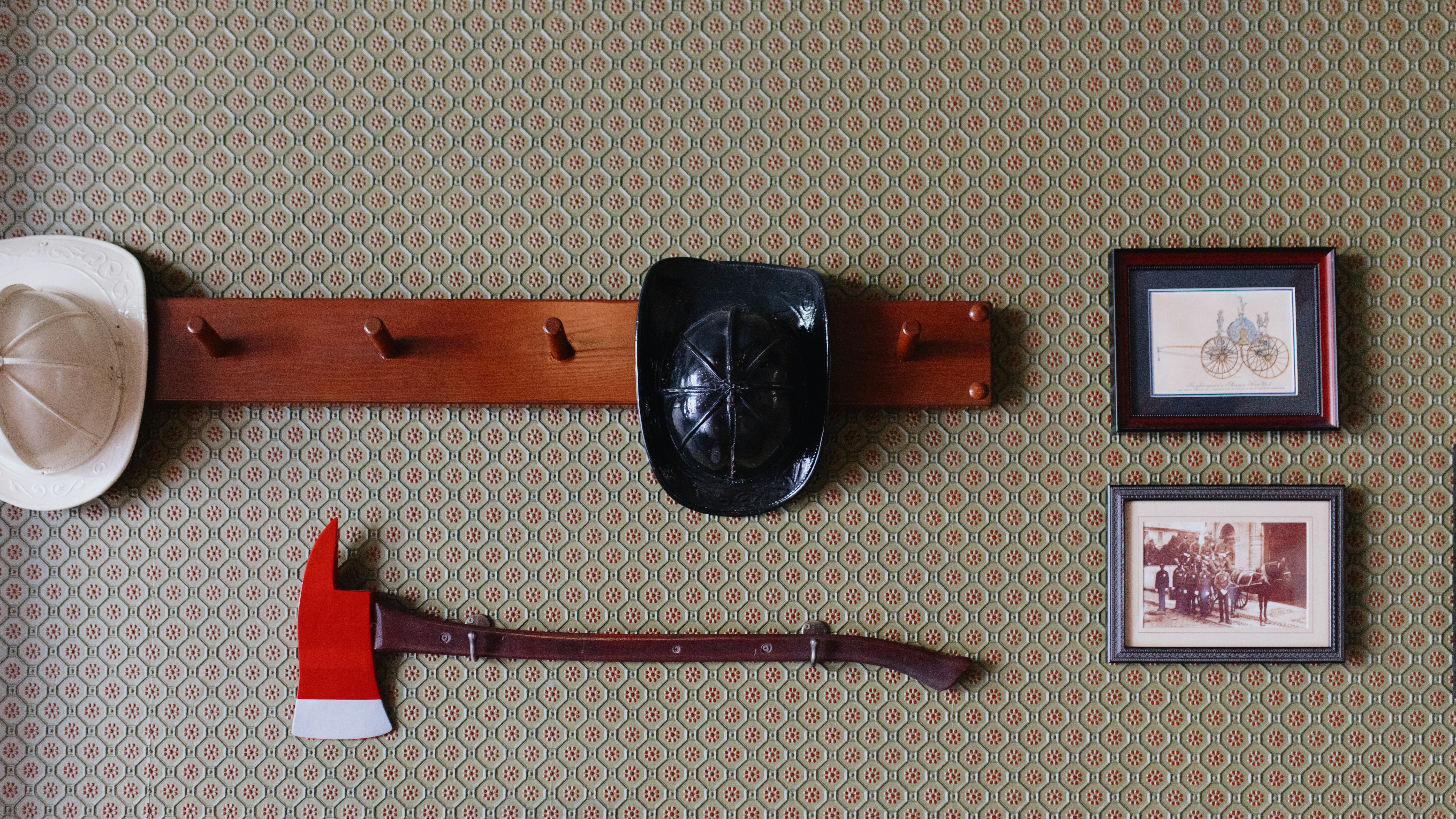 Hanging Memories: A Vintage Wall Display of Coats, Hats, and Frames