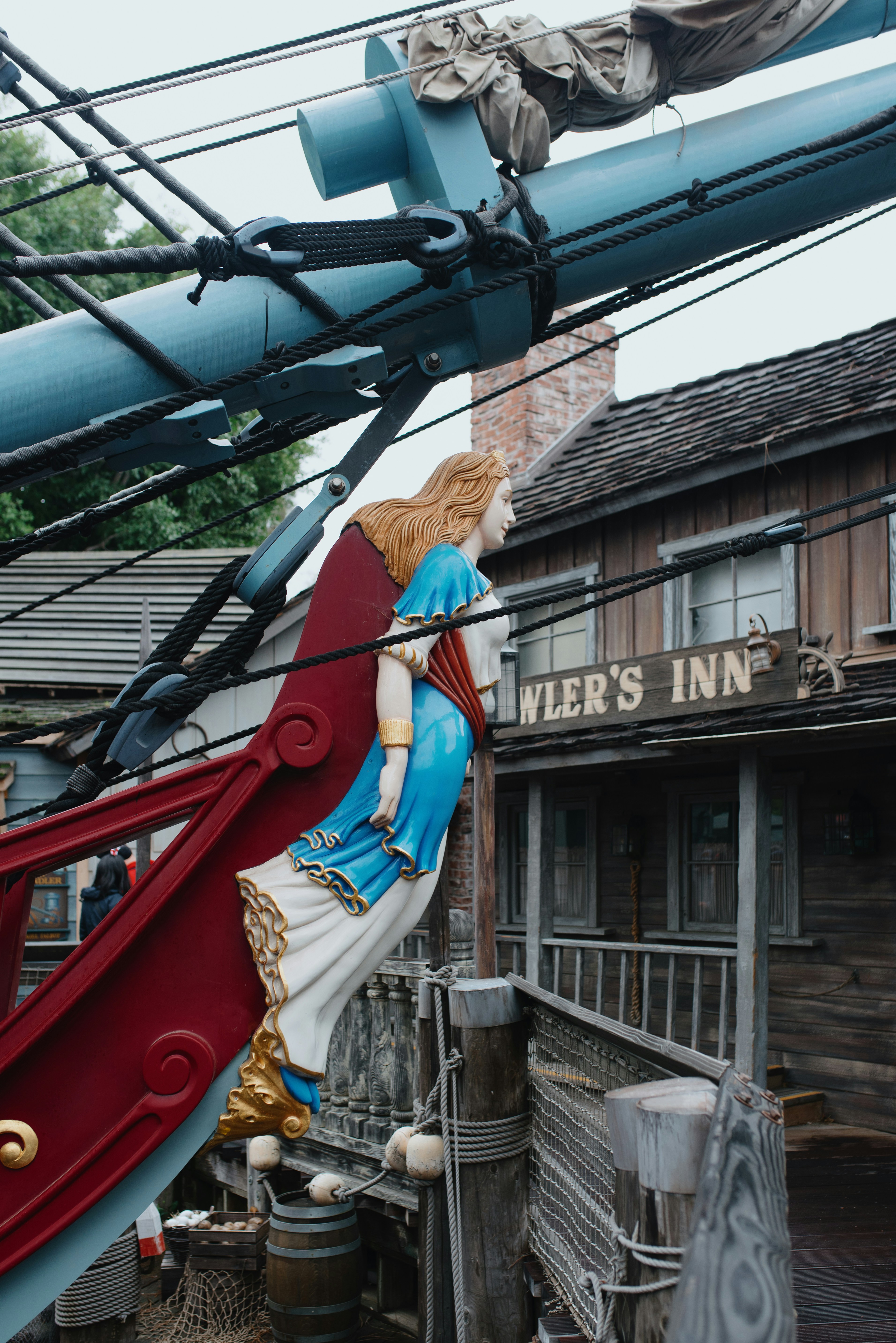 Sailor’s Crest: A Colorful Figure Amid Tangled Rigging by the Inn