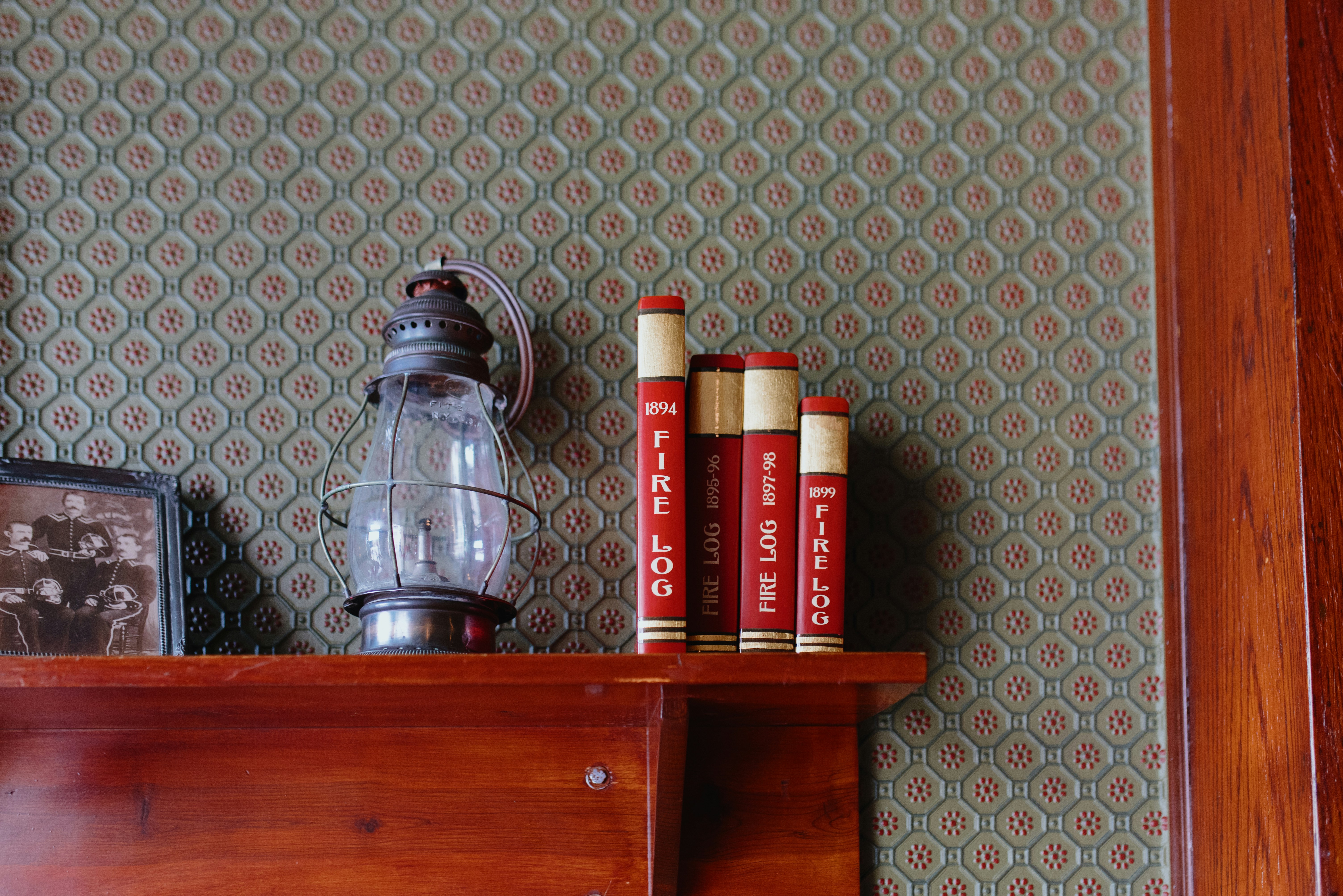 Antique Mantel Wisdom: Lantern and Timeworn Books