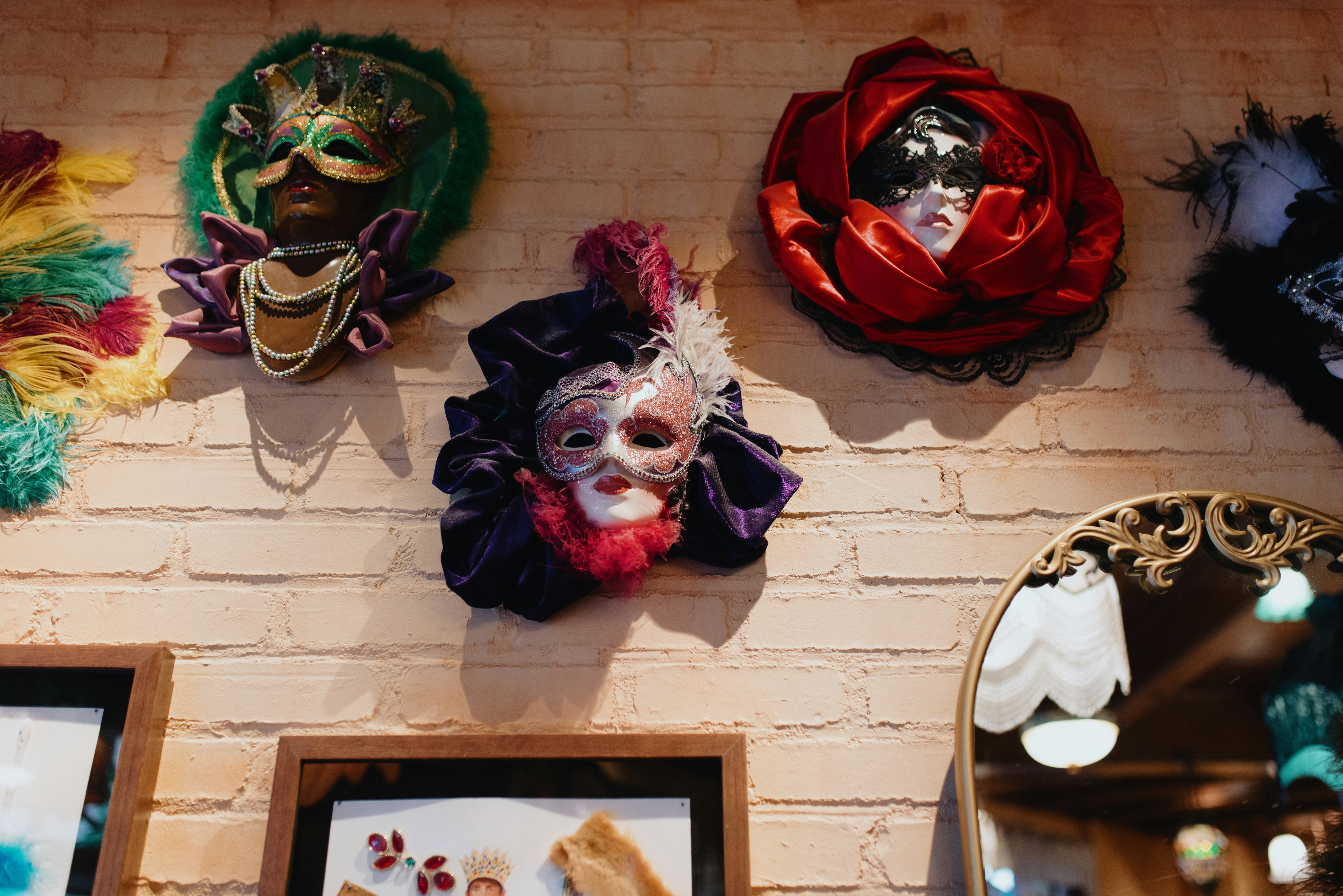 Mask Gallery on a Lavender Brick Wall