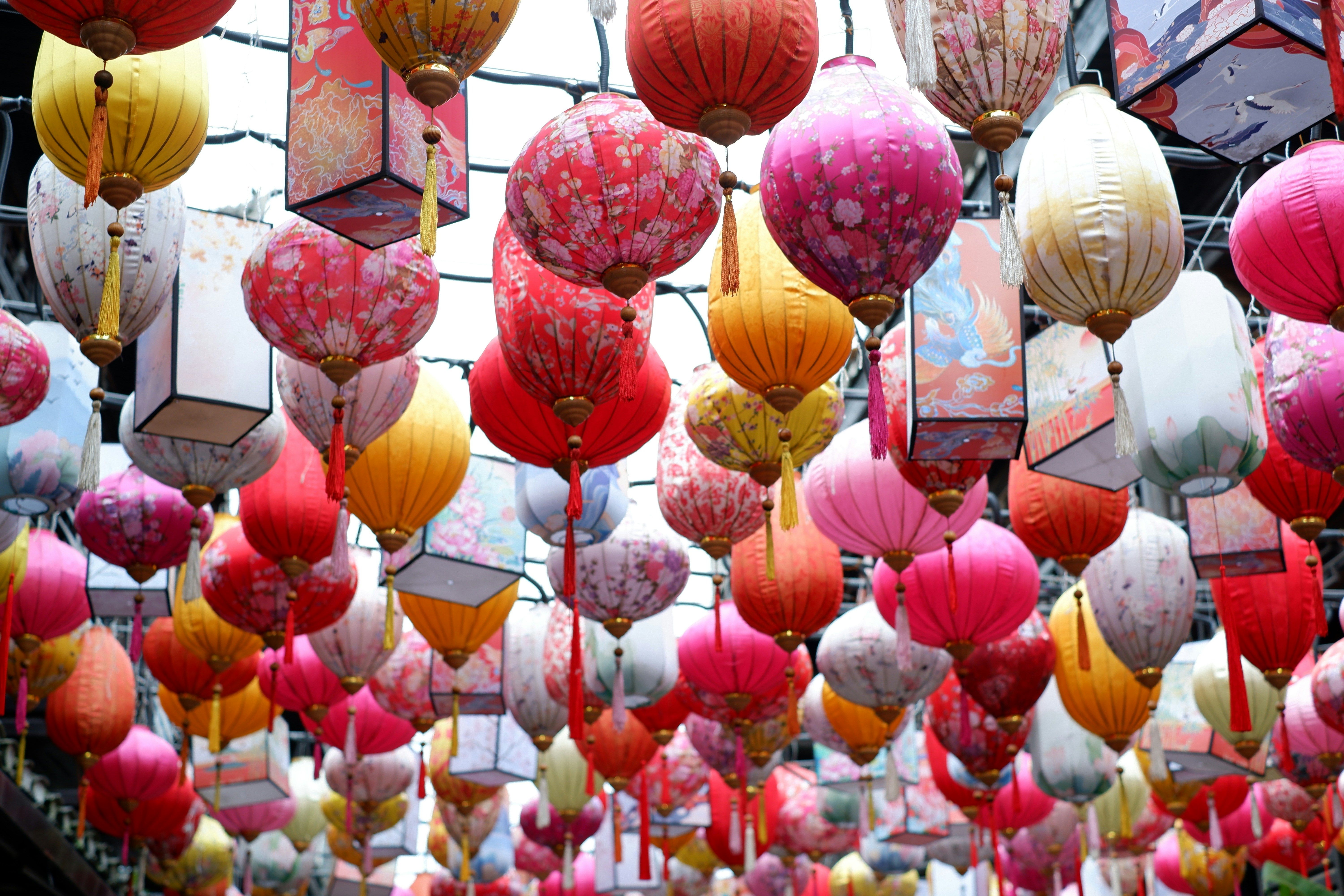 A ceiling of lanterns: a tapestry of lantern hues in a festive street