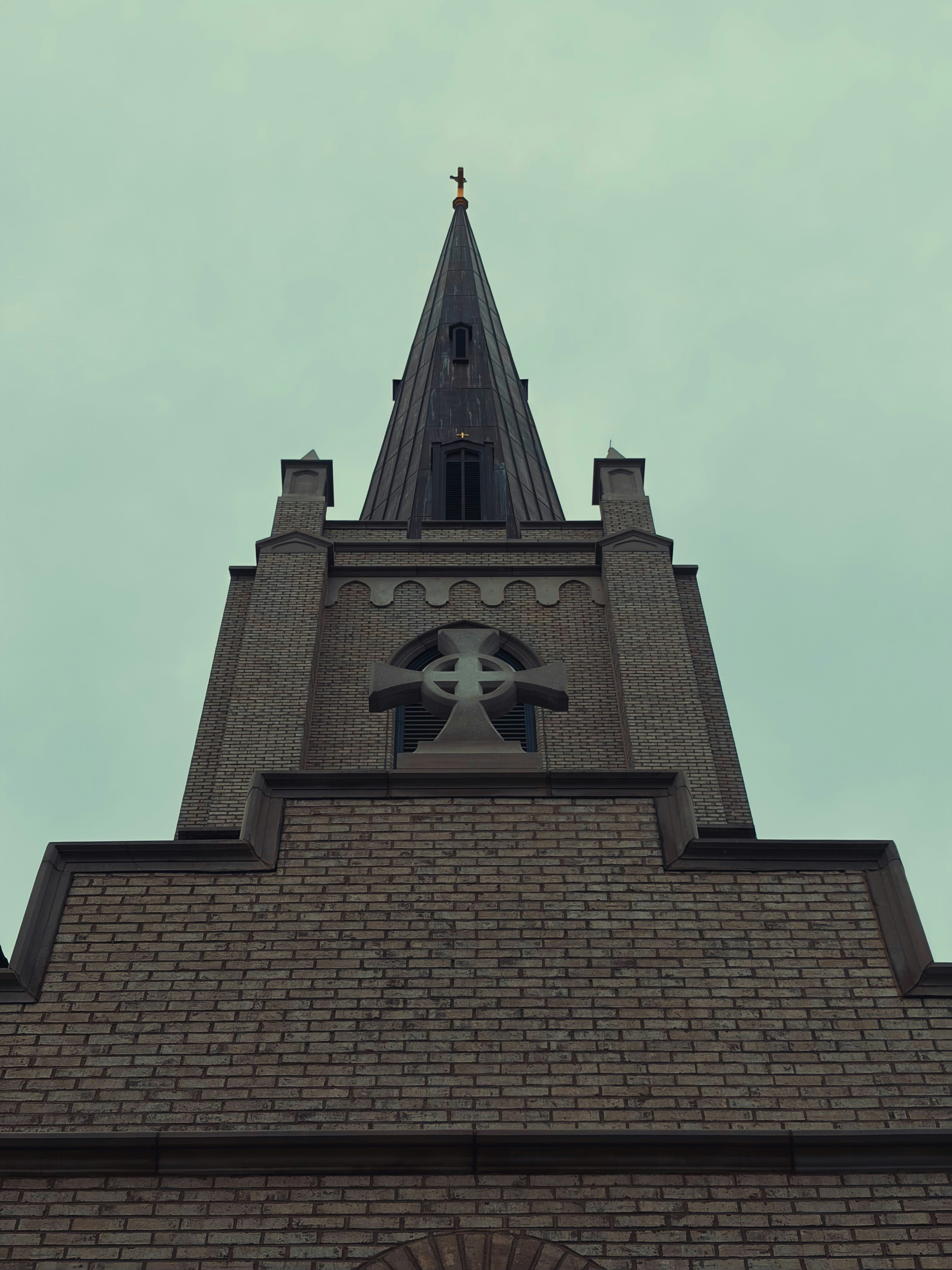 Upward Gable: The Tower Reaches Toward a Pale Sky