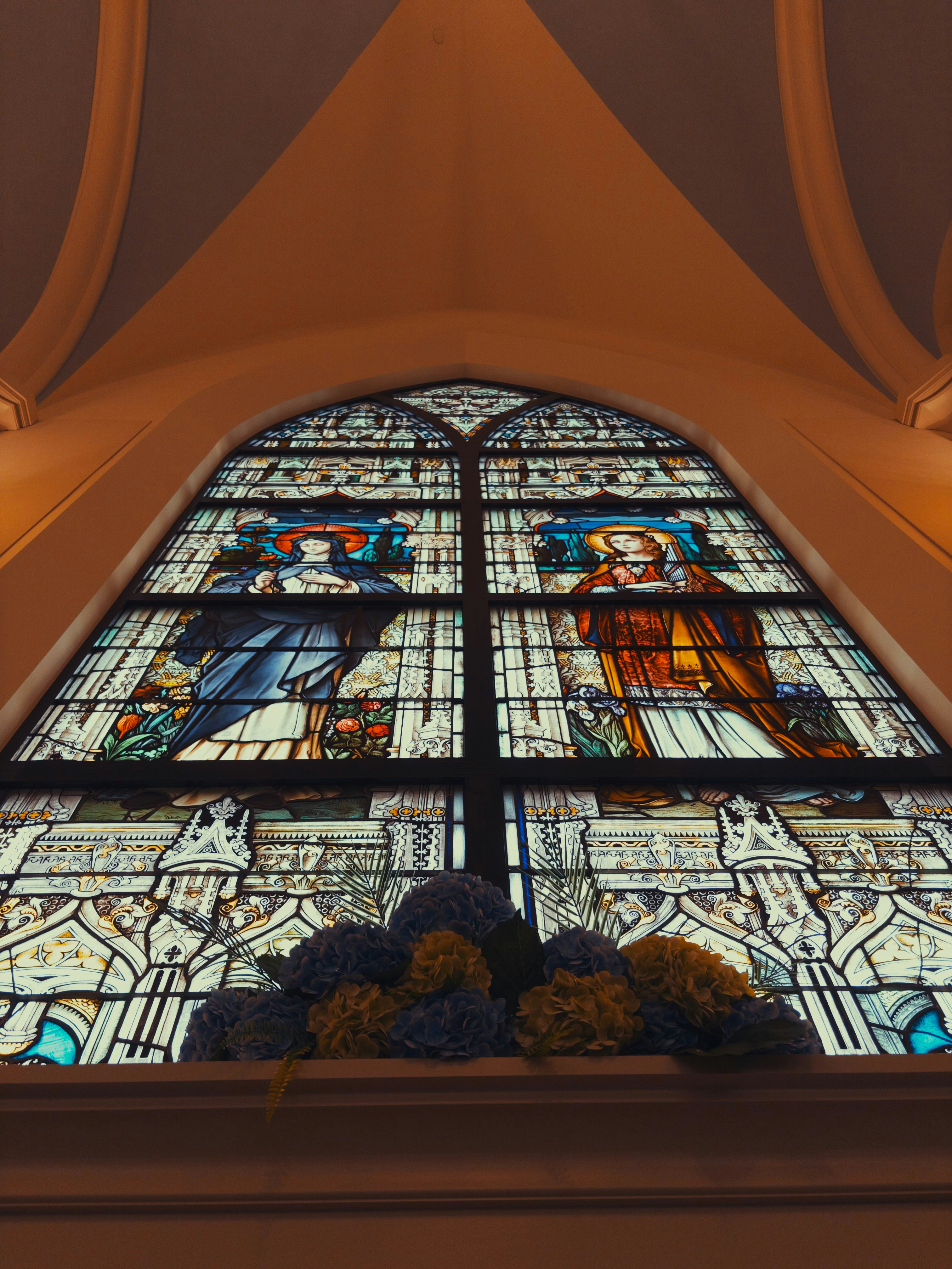 Stained Glass Arches: Heavenly Figures Framed by Floral Foreground