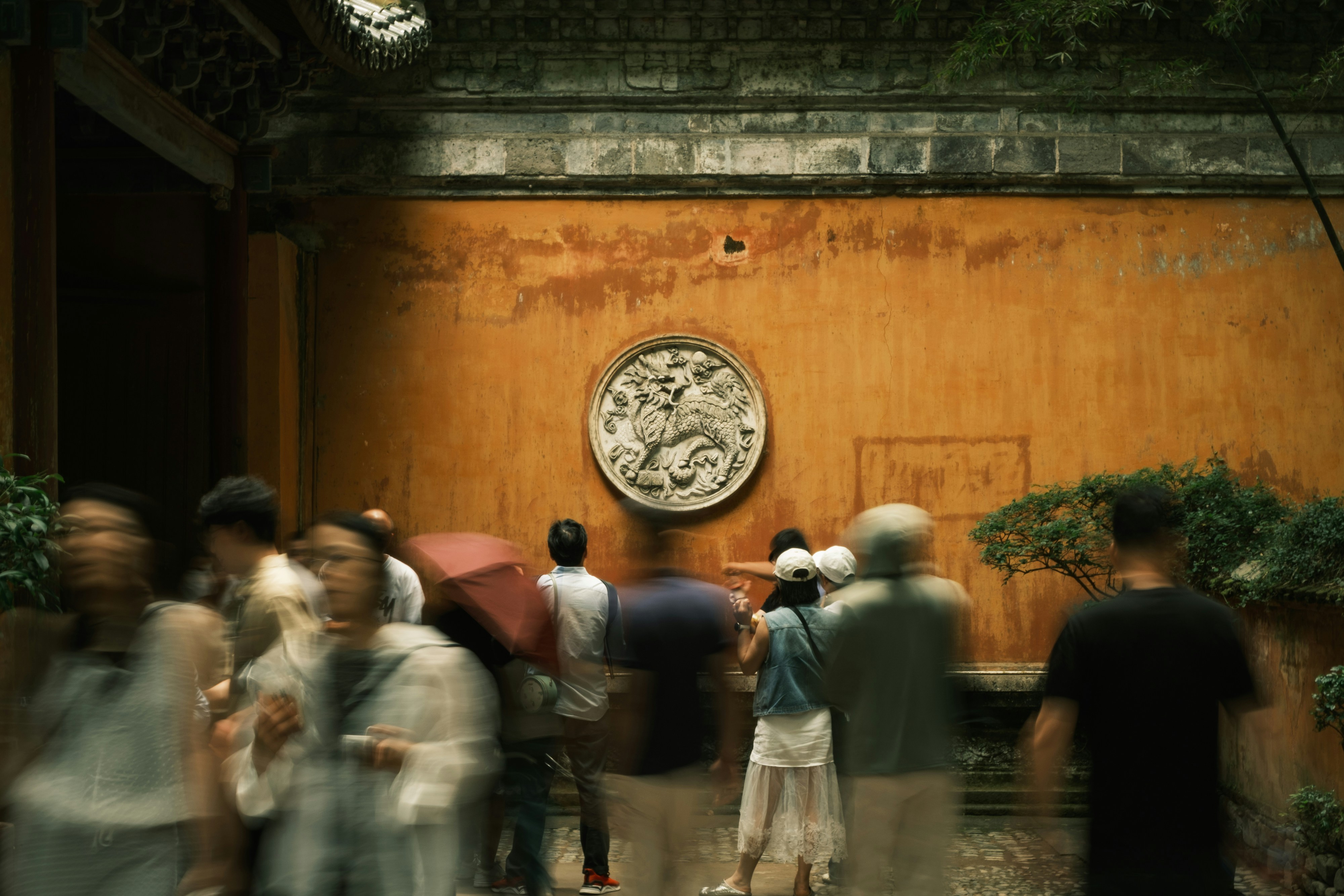 Mid-Crammed Courtyard Moment Under a Carved Emblem