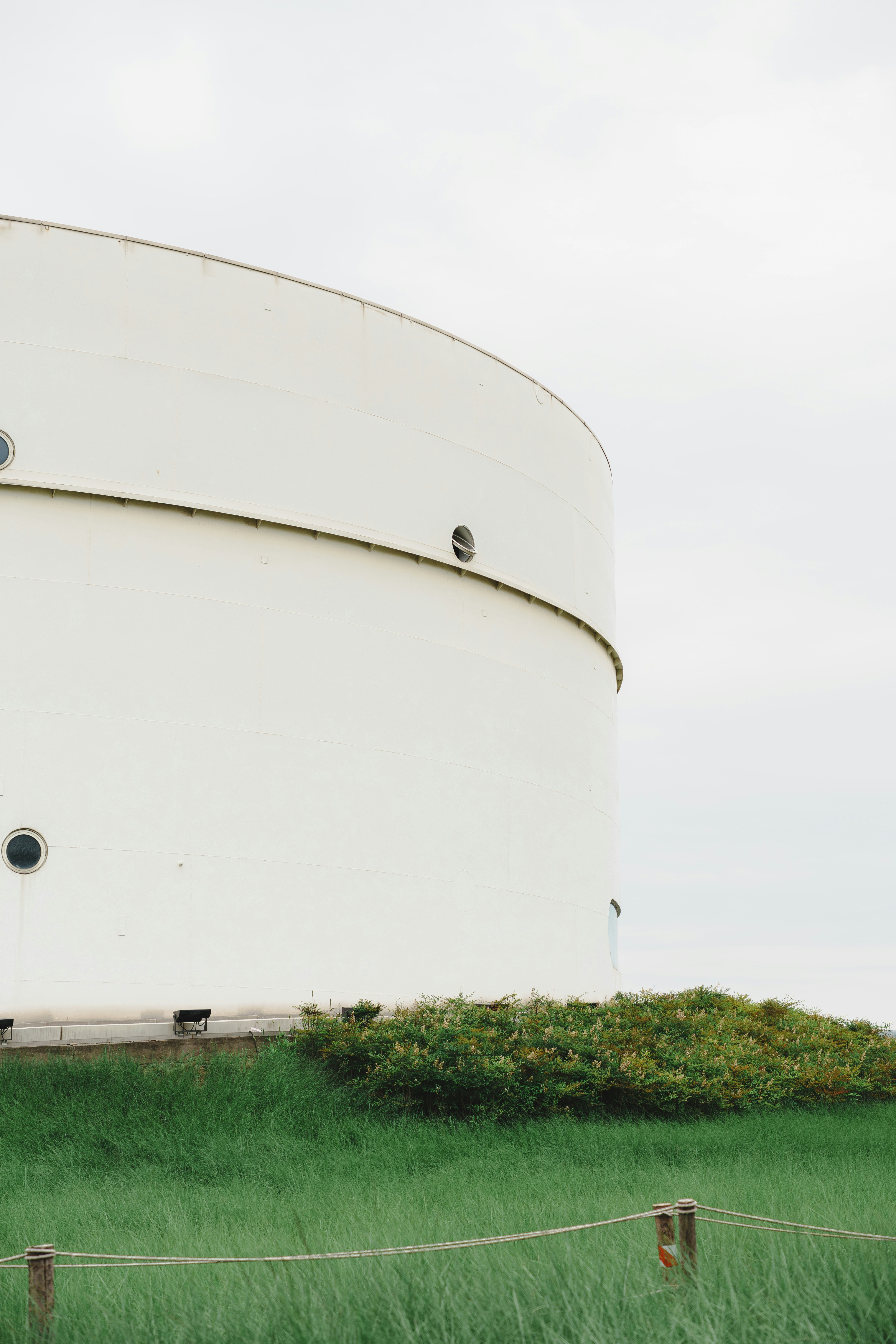 White Cylindrical Structure Meets Rolling Green Knoll
