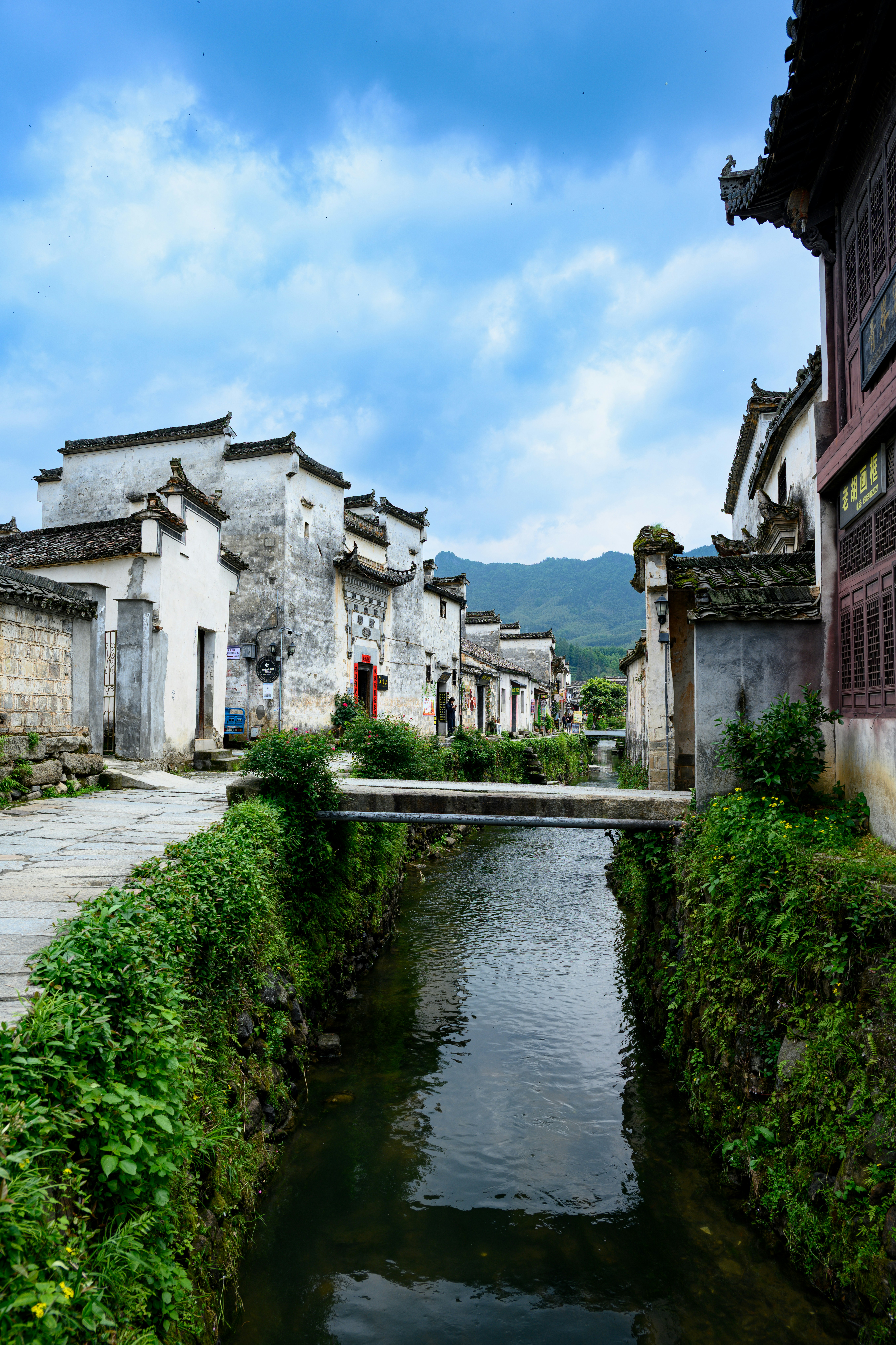 Canal between White-walled Villages under a Blue Sky