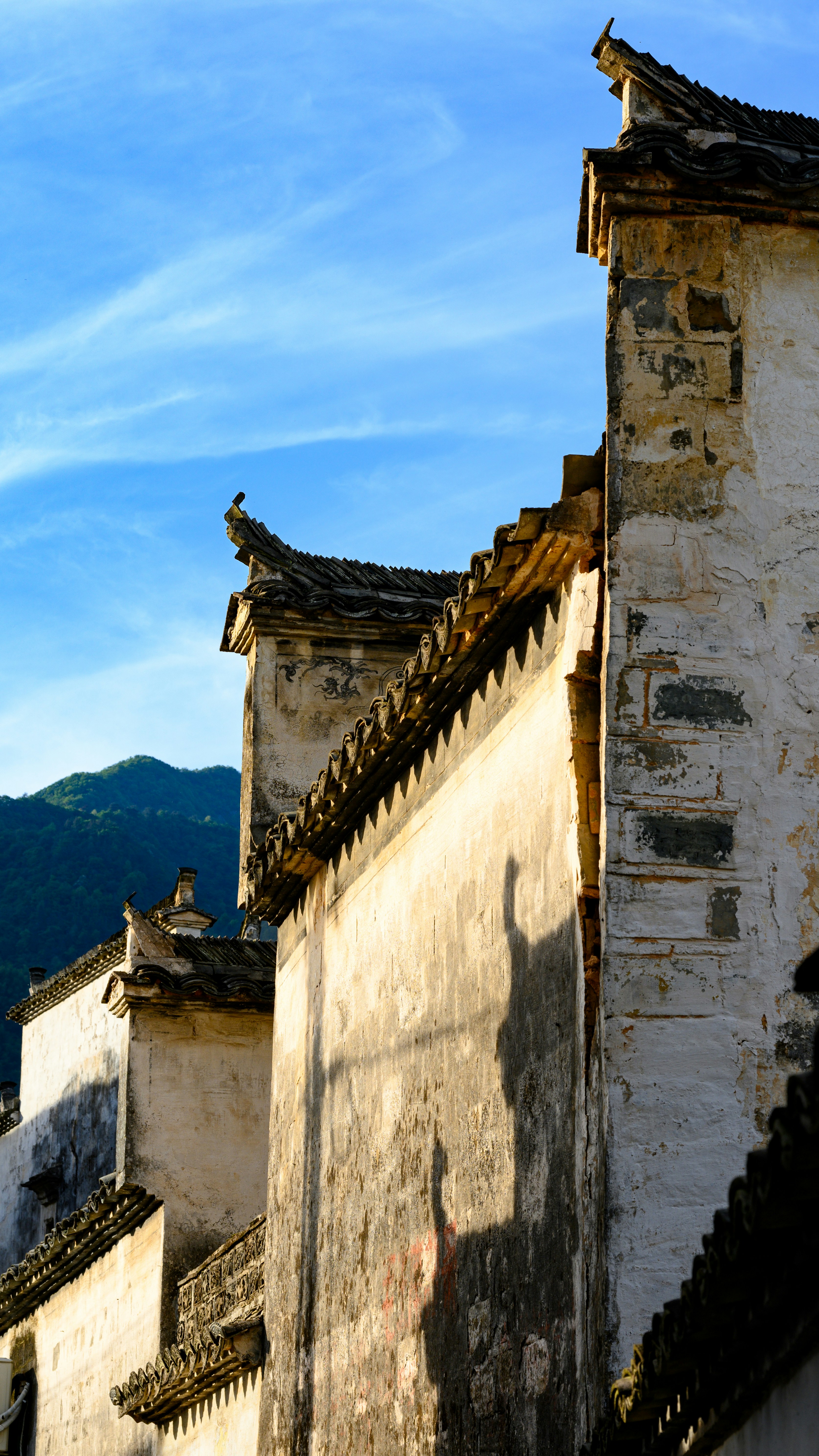 Sunlit walled terraces rise against a blue sky
