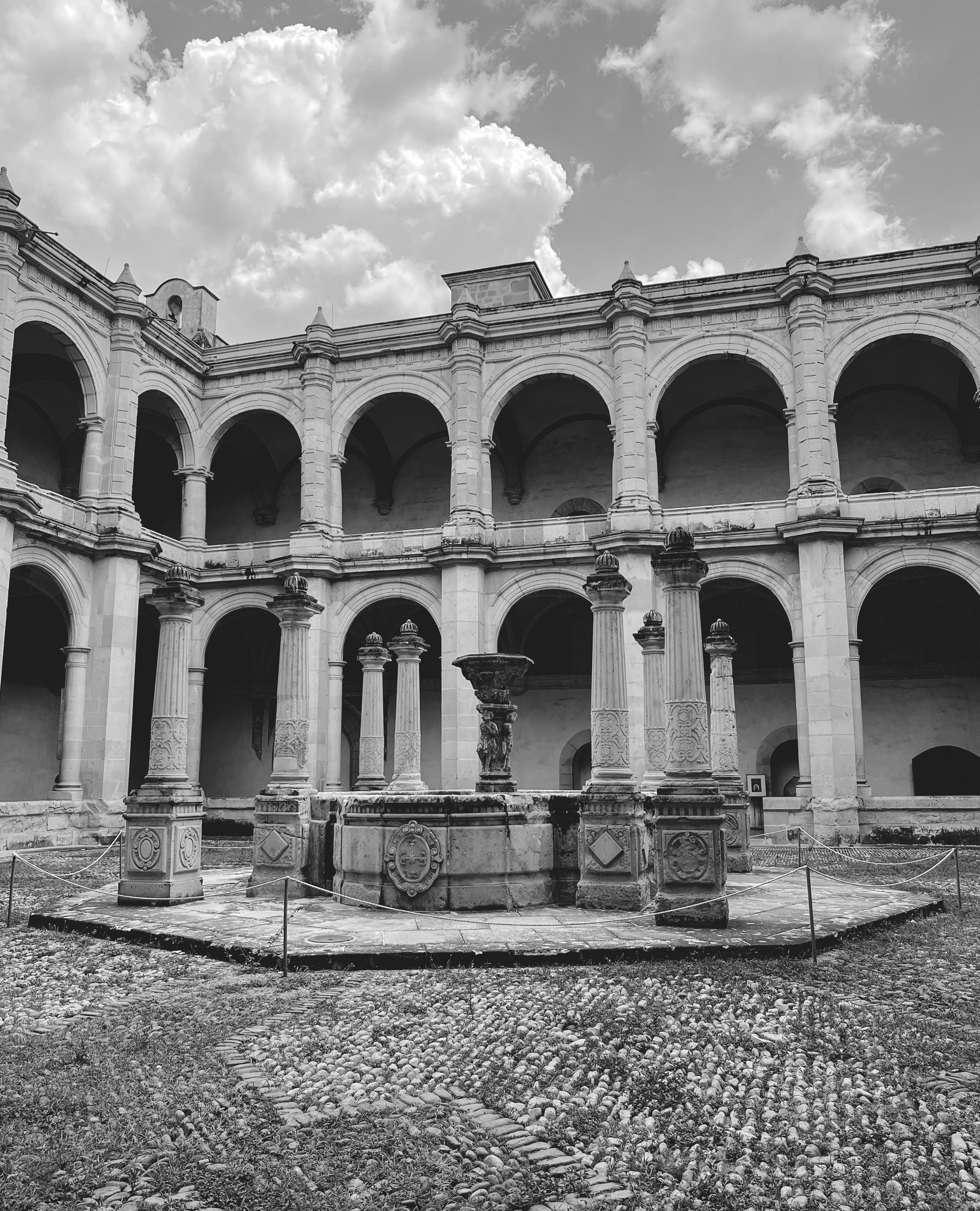 Courtyard of Stone: A Circular Fountain Enshrined by Arches