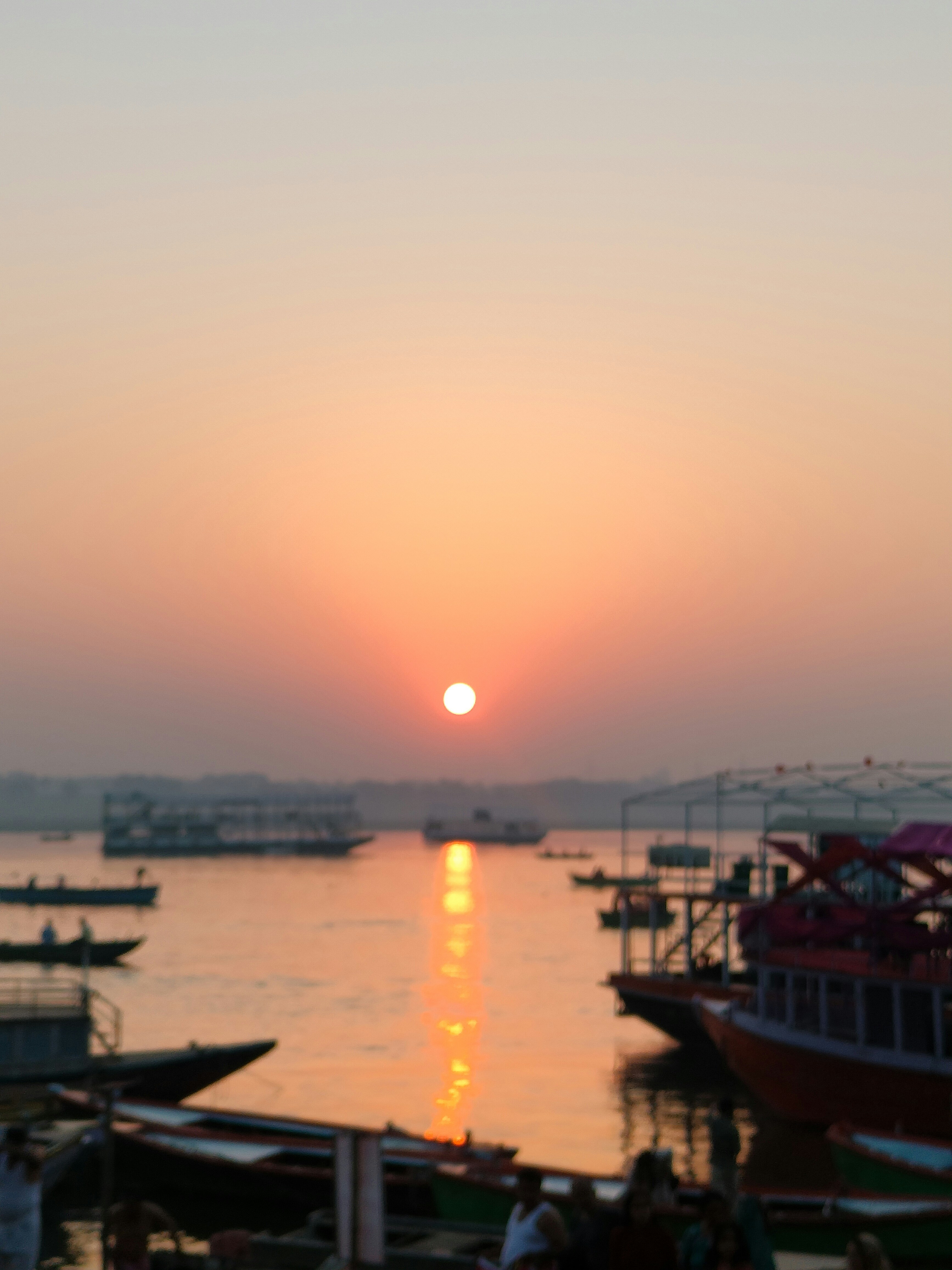Sunlit Harbor at Dusk: Boats, Calm Water, and a Simple Ball of Light