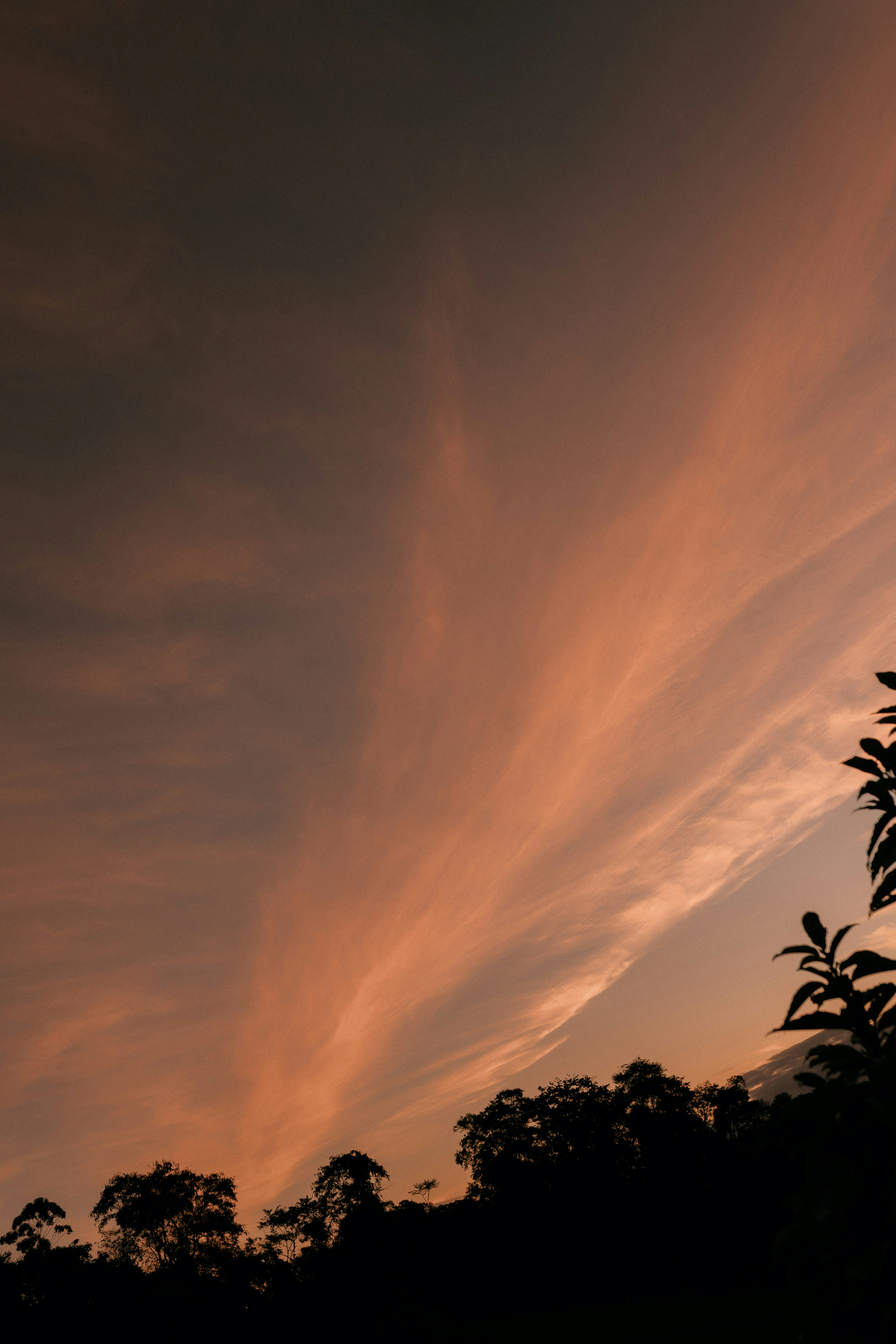 Silhouette at Sunset: Cloudscoured Sky Over Quiet Horizon
