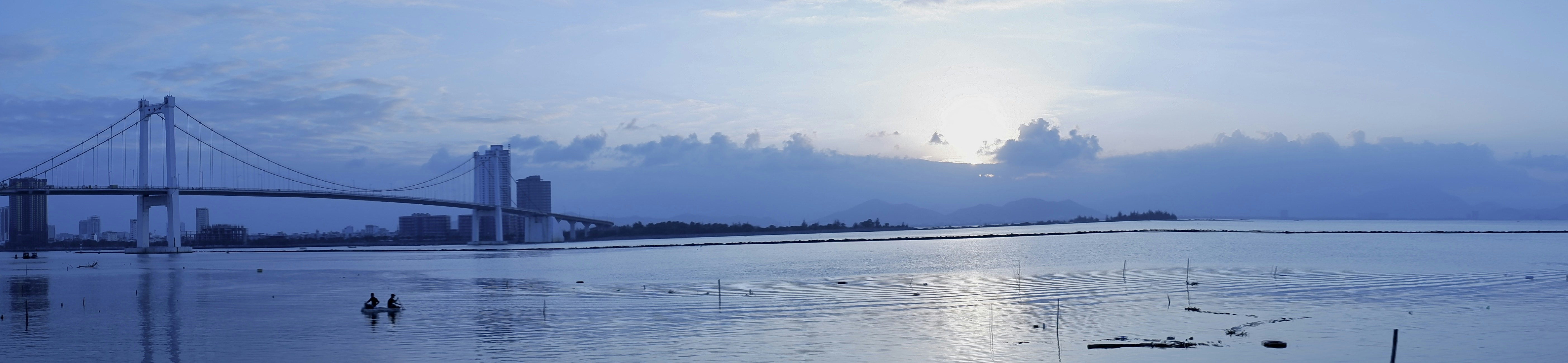 Distant Horizon: A Quiet Waterfront Under a Waning Blue