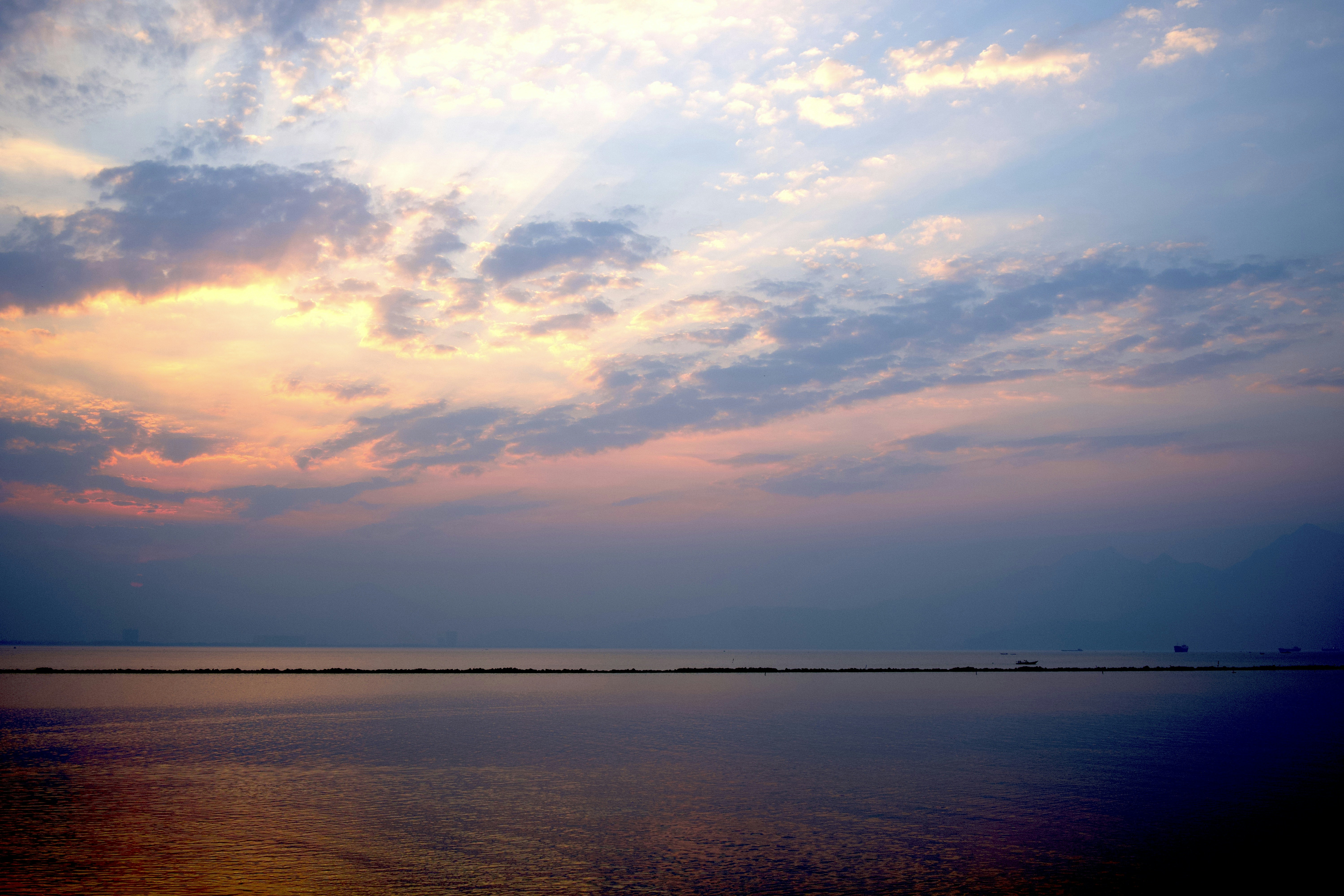 Dawn Over Quiet Waters: A Horizon Breathing Light